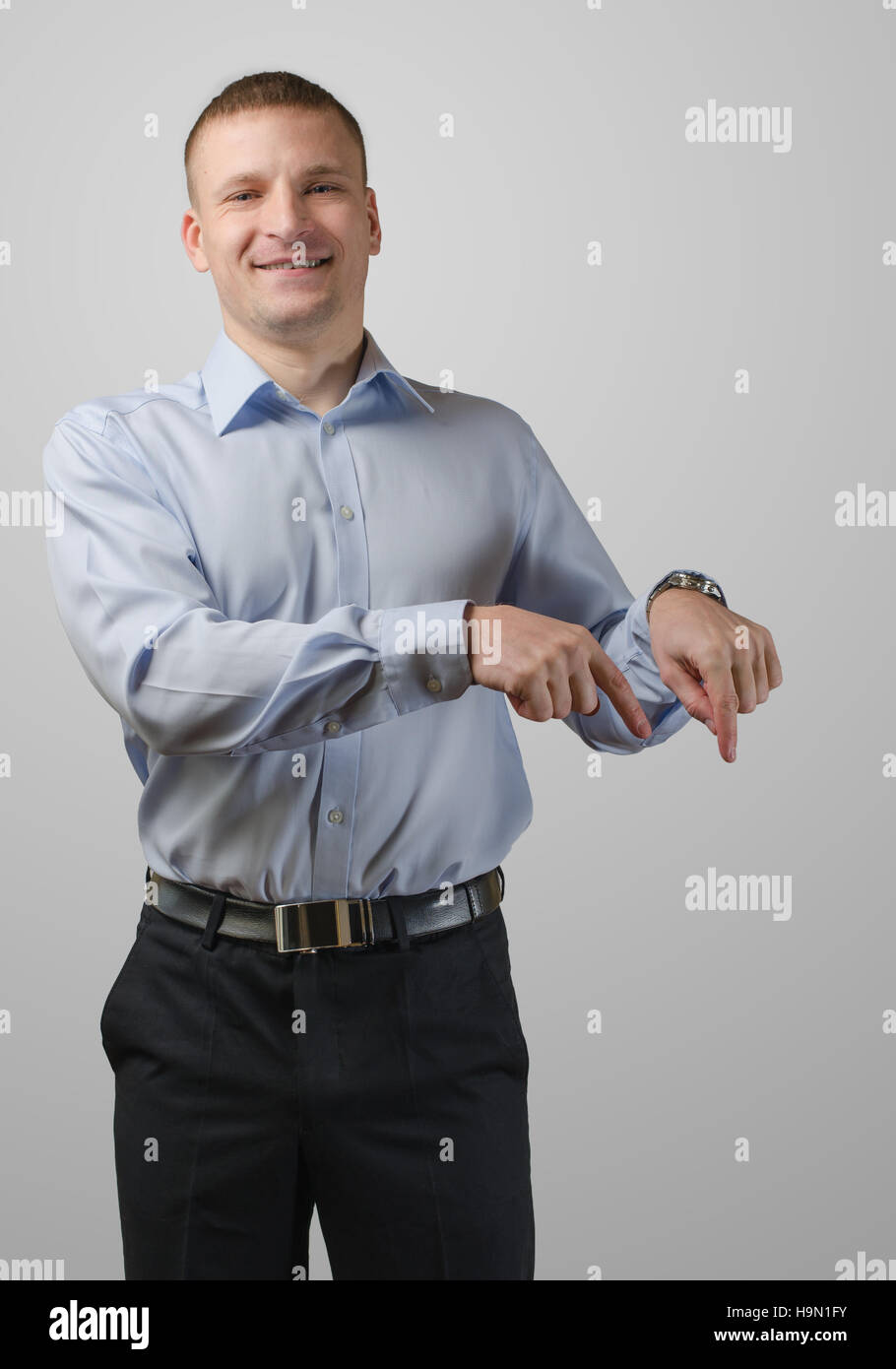 Young man points his hand at something. Isolated on white background ...