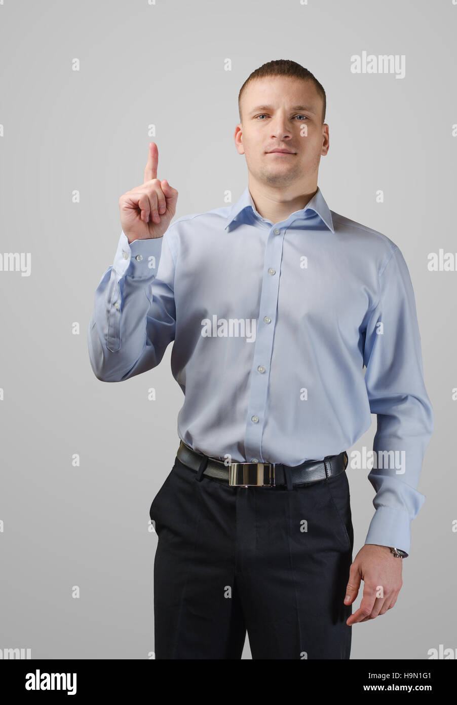 Young man points his hand at something. Isolated on white background ...