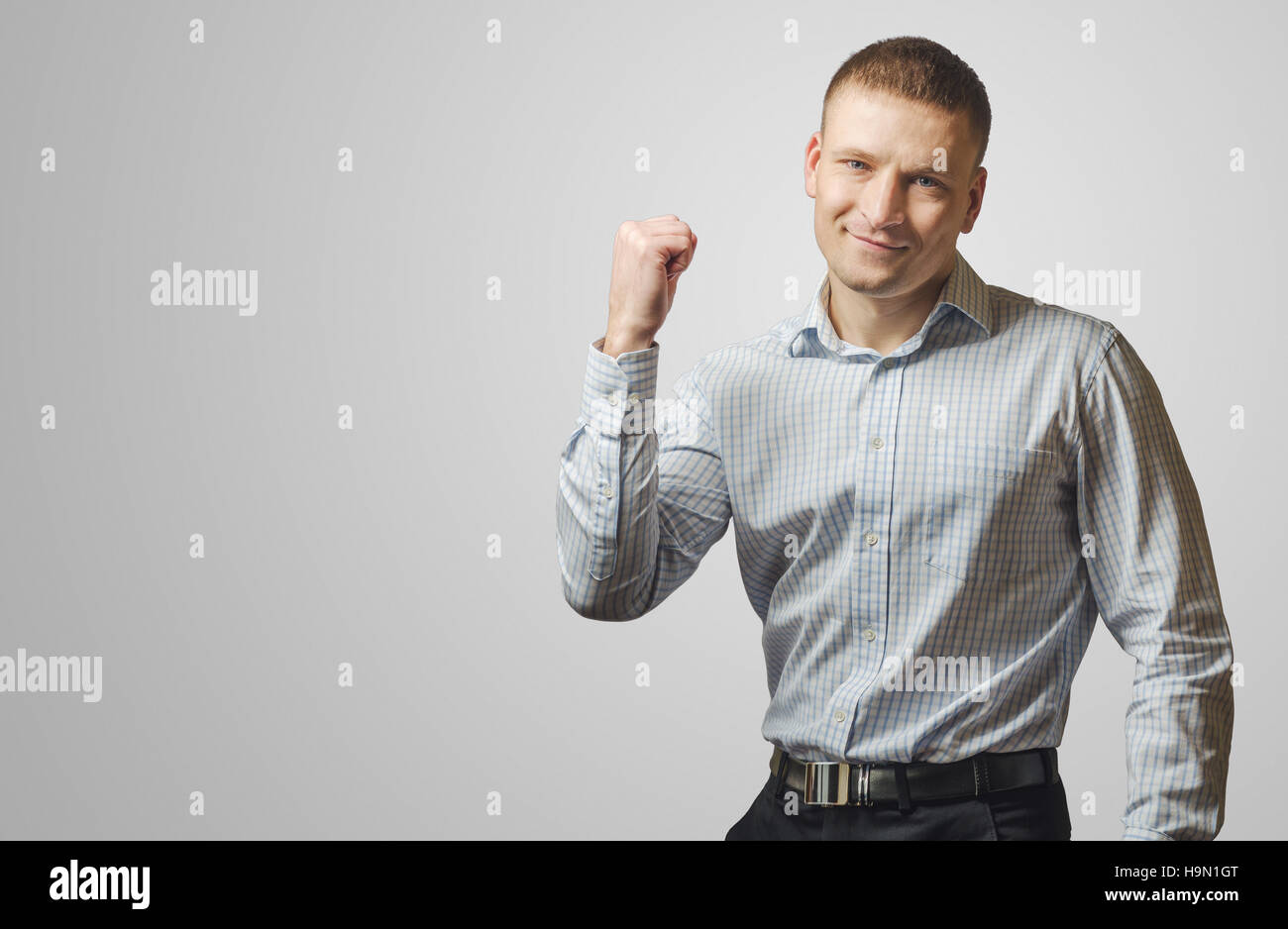 Young business man showing his hands mark "yes". Isolated on white ...