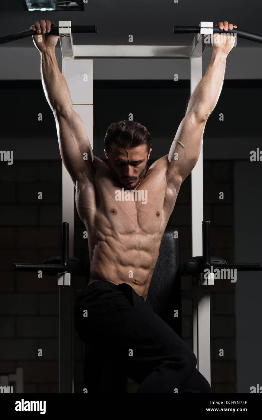 Handsome Man Performing Hanging Leg Raises Exercise - One Of The Most ...