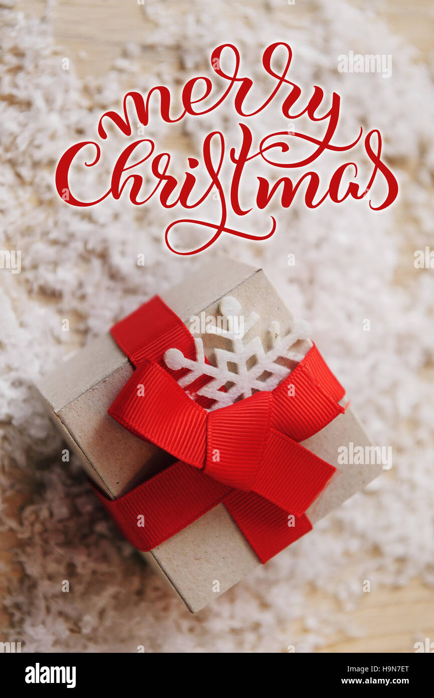 gift box of kraft paper with Red Ribbon and Merry Christmas text ...