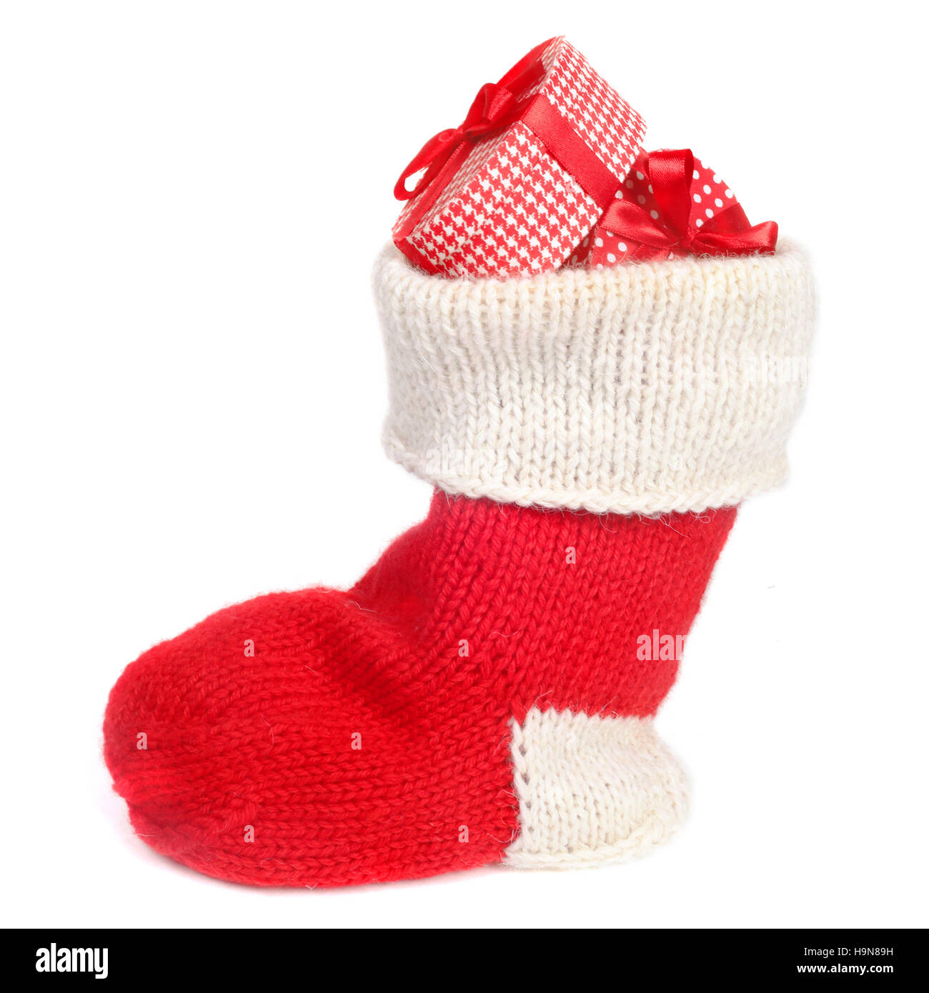 Red Christmas sock with gifts isolated on white background Stock Photo ...