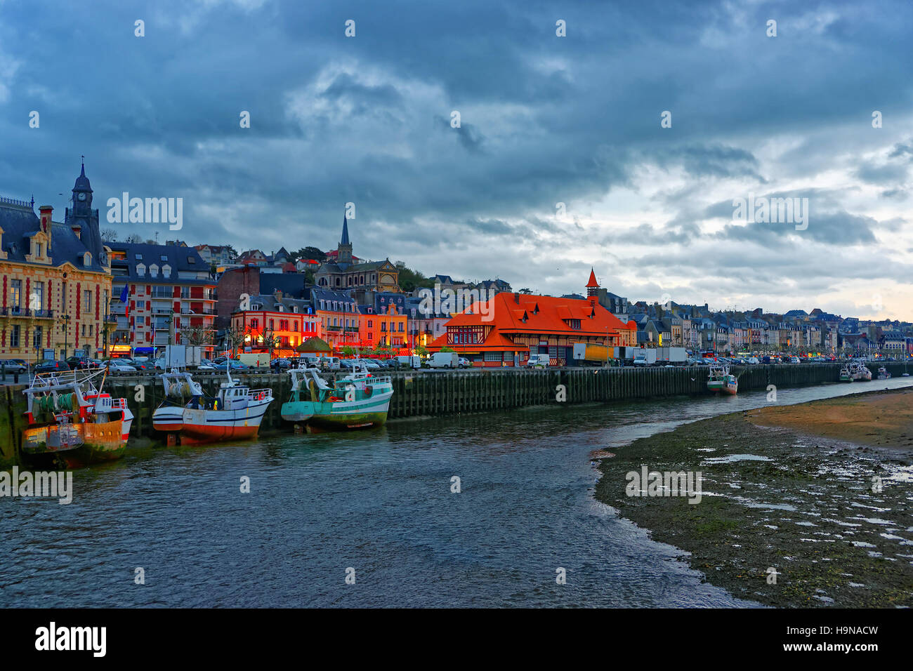 Sunset at the embankment of Touques river in Trouville-sur-Mer, or ...