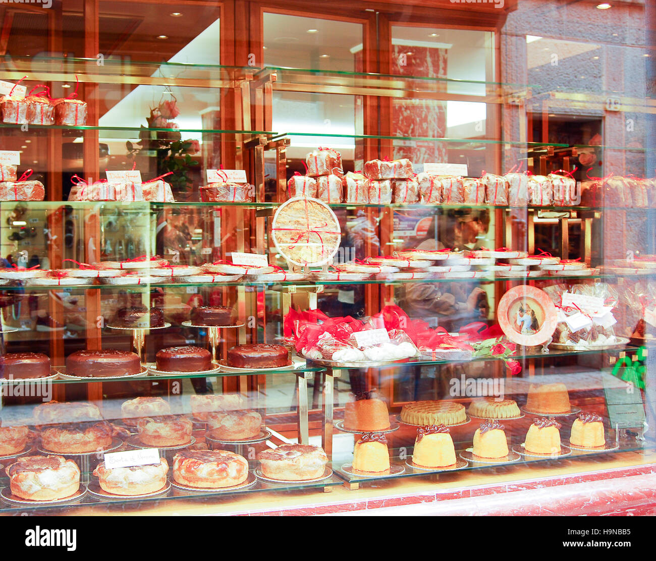 A bakery displays pastries and other stuffs in its window in Verona ...