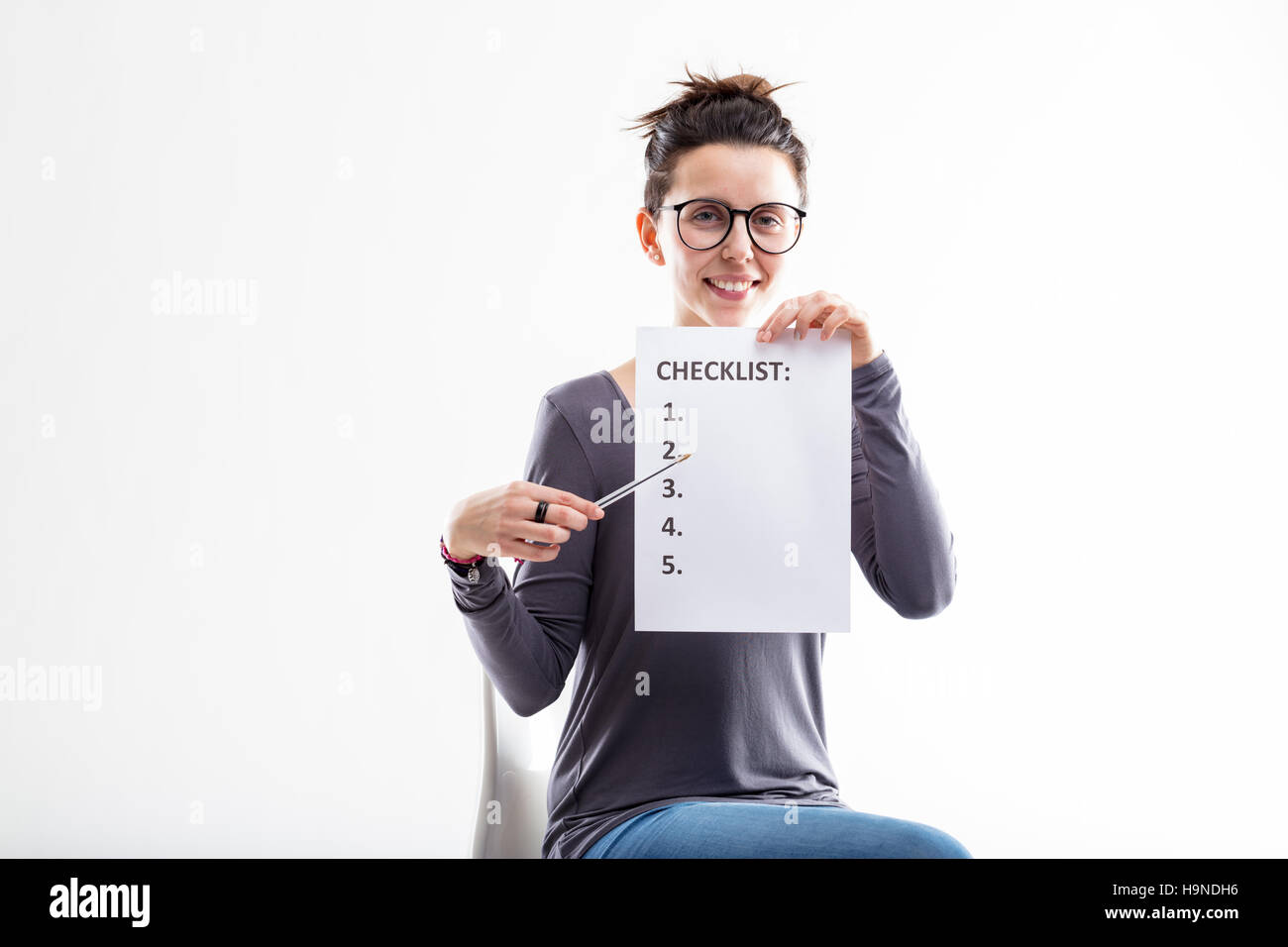 young woman suggestion is to follow a complete checklist Stock Photo ...
