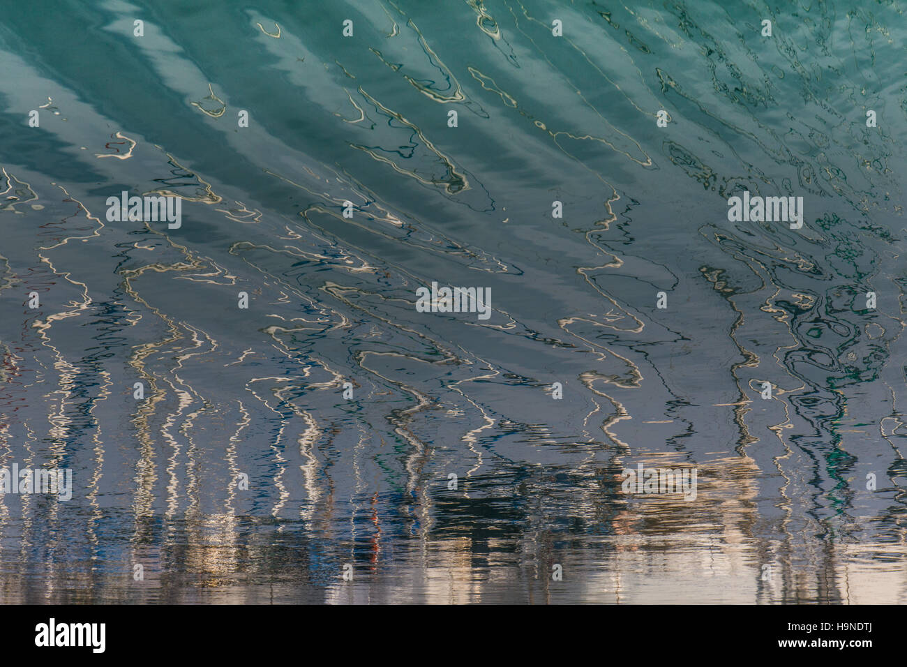 distorted reflection of boats in water at marina Stock Photo - Alamy