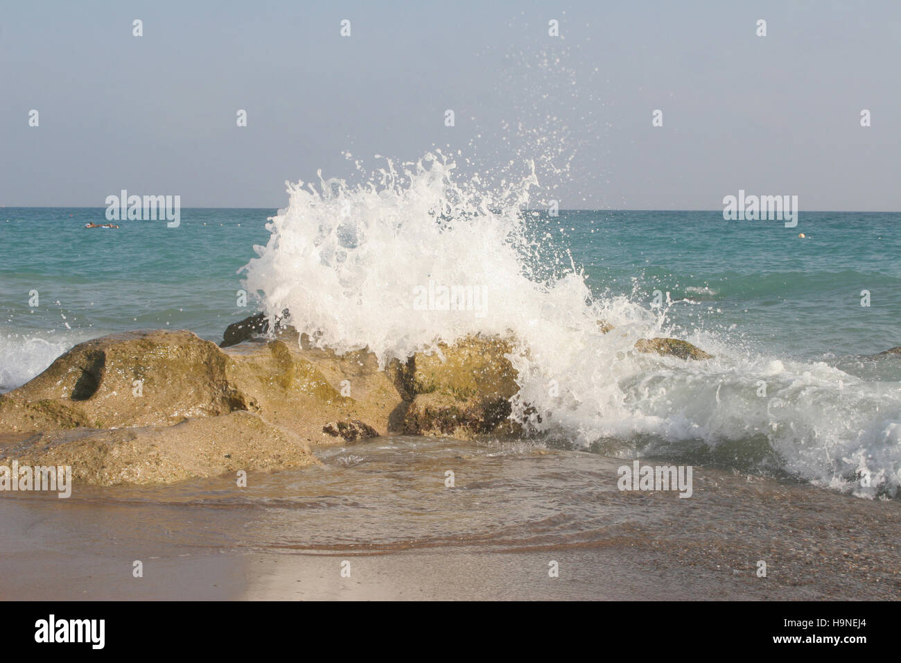 Sea wave is breaking on the stone Stock Photo - Alamy