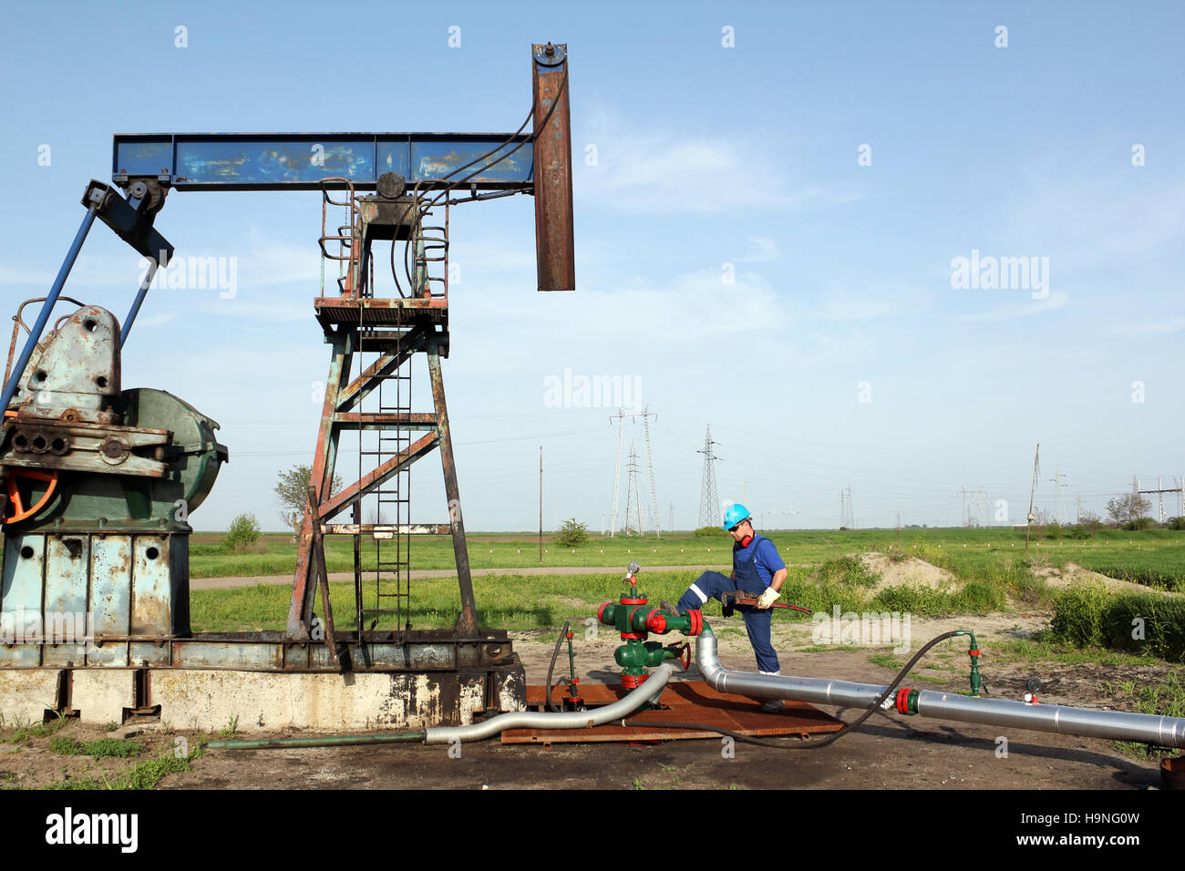 oil worker with wrench on oil field Stock Photo - Alamy