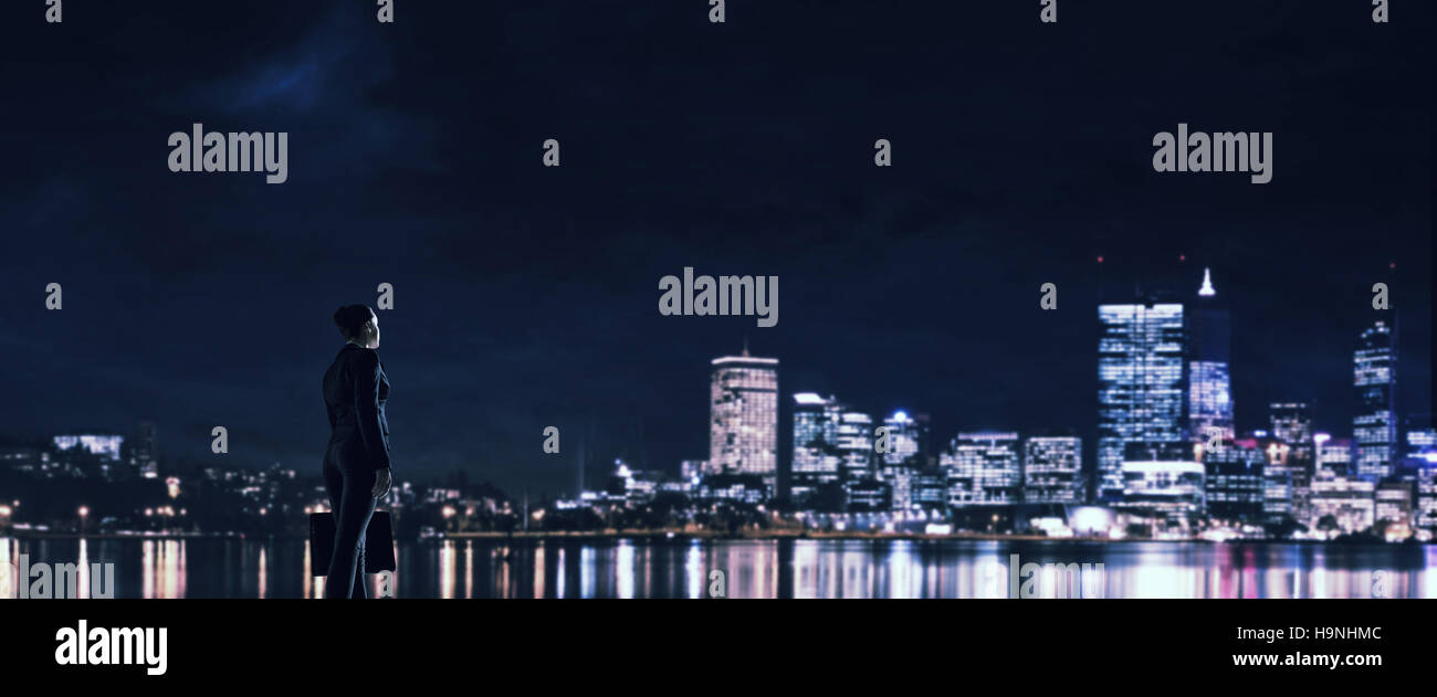 Businesswoman viewing night glowing city Stock Photo - Alamy