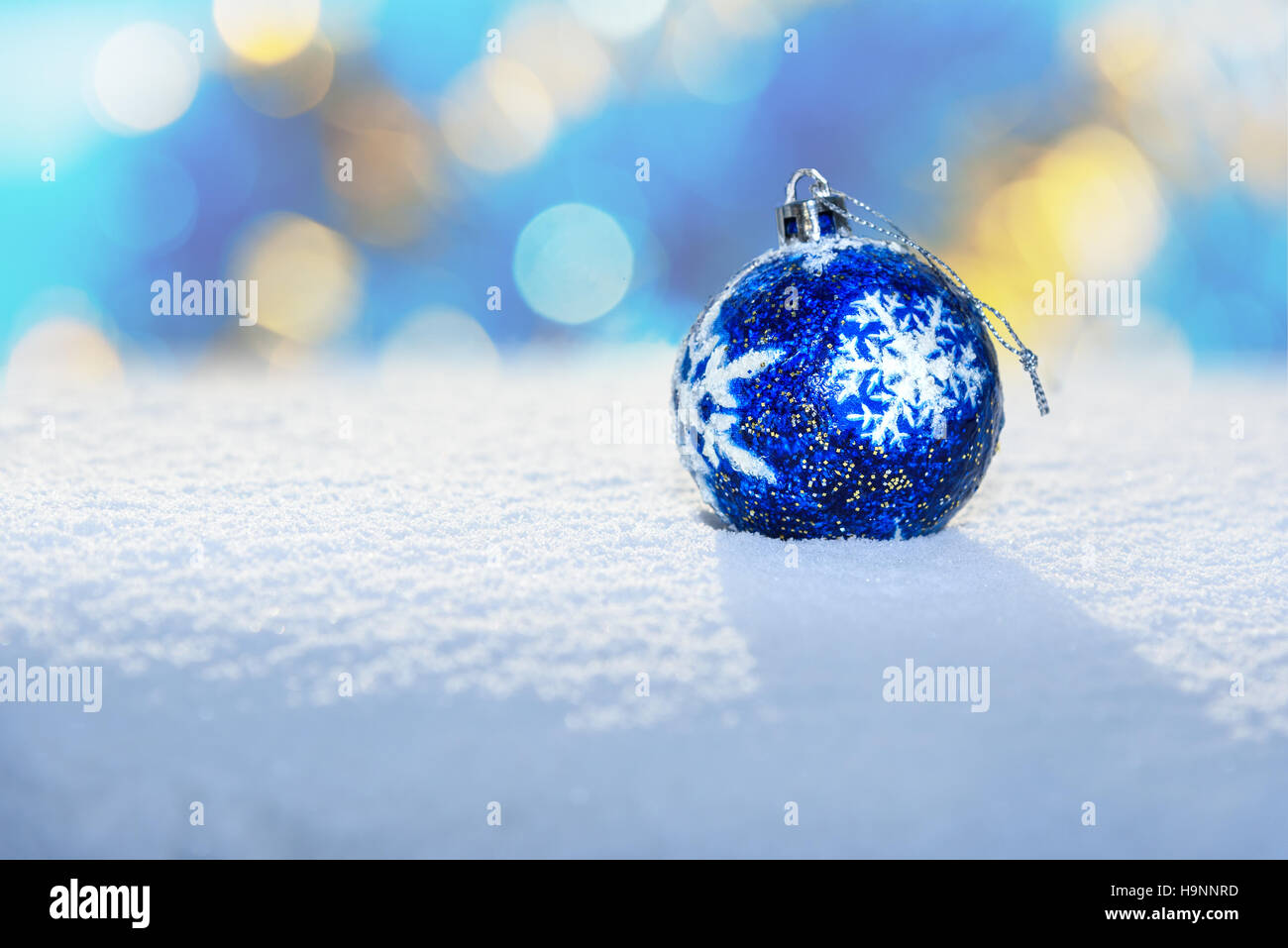Blue Christmas Ball on snow Stock Photo - Alamy