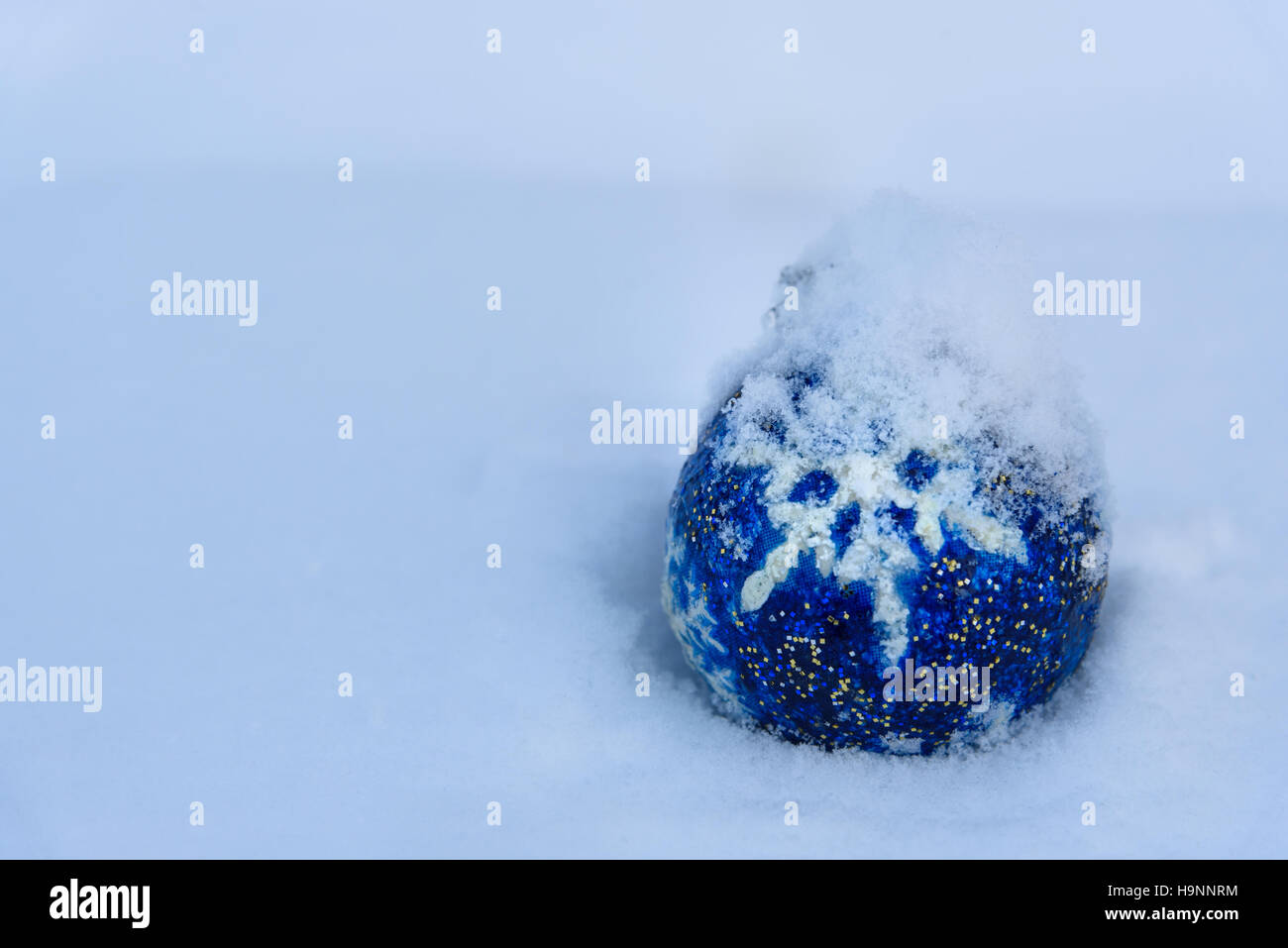Blue Christmas Ball on snow Stock Photo - Alamy