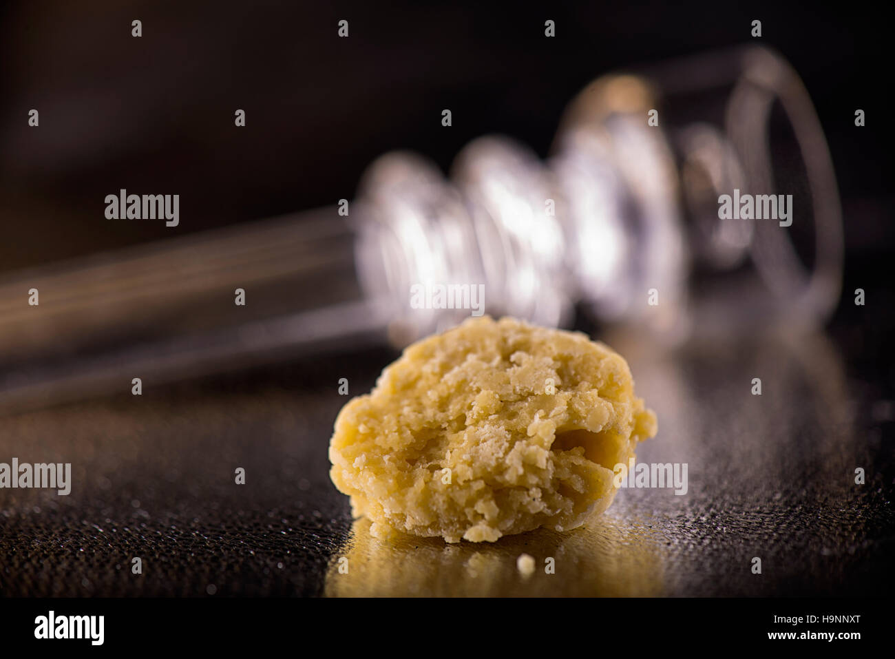 Marijuana extraction concentrate aka wax crumble on dark background ...