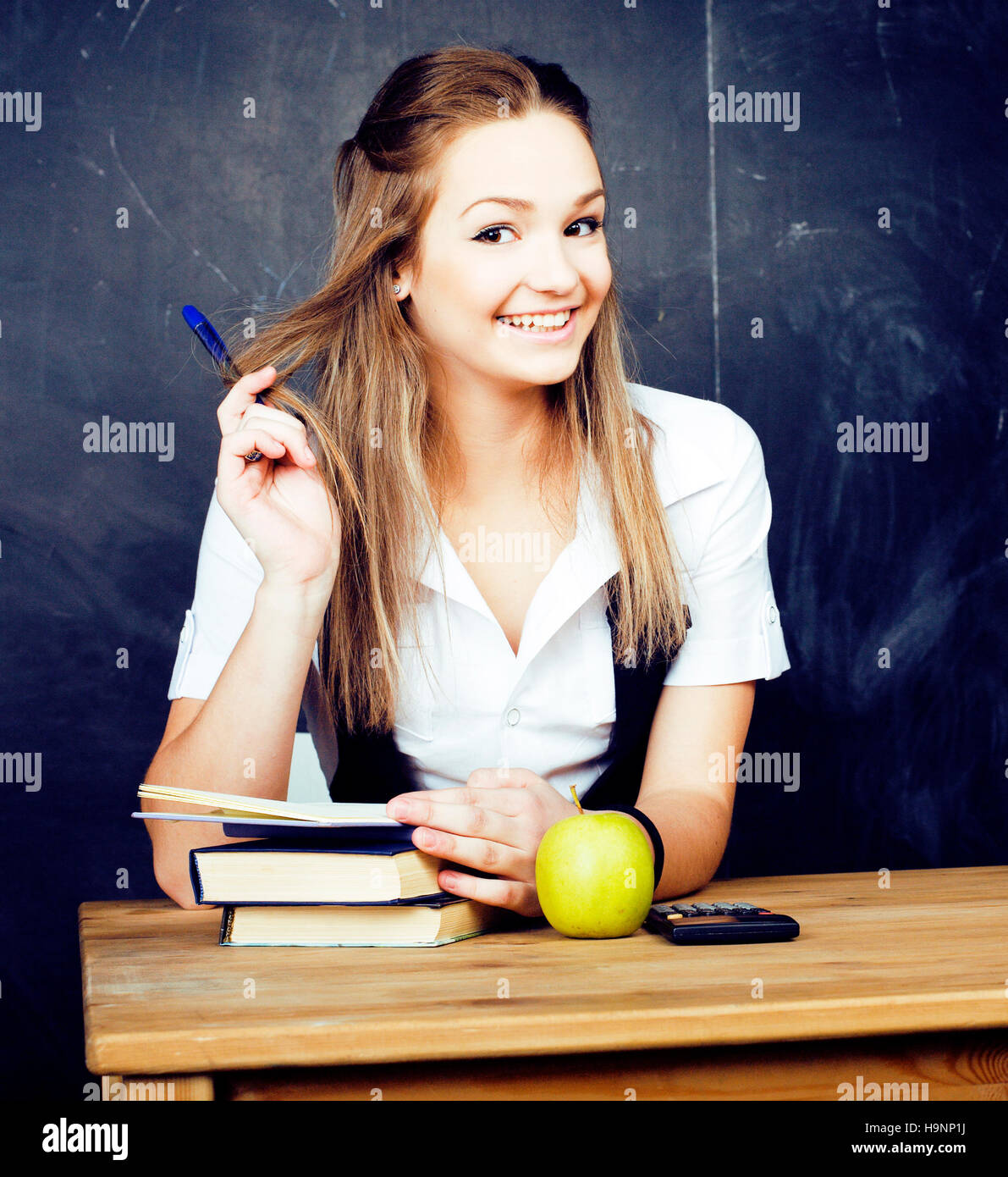 portrait of happy cute student with book in classroom Stock Photo - Alamy