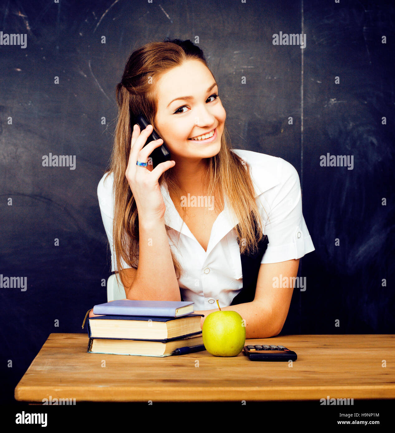 portrait of happy cute student with book in classroom Stock Photo - Alamy
