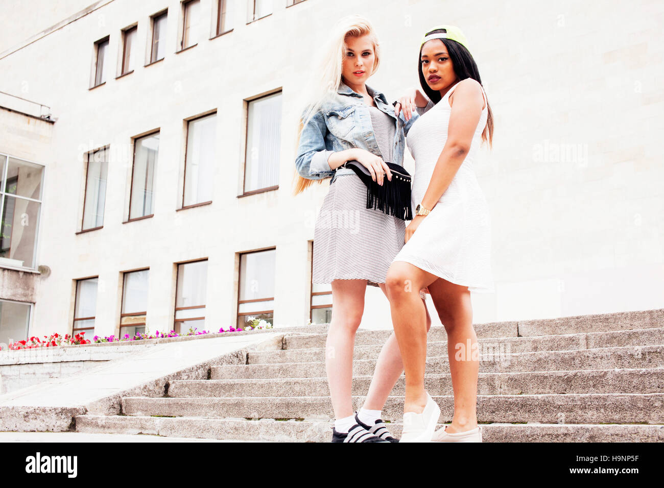Two teenage girls infront of university building smiling, having Stock ...