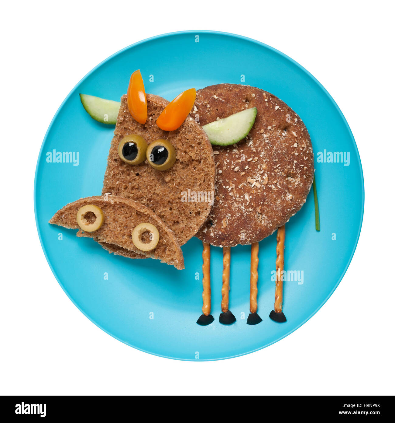 Cow made of bread and vegetables on blue plate Stock Photo - Alamy