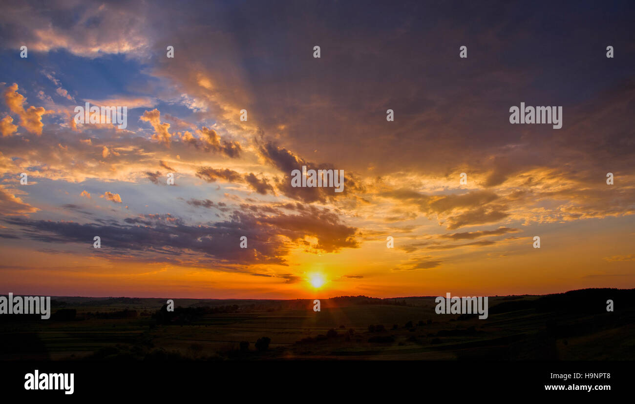 sunset over meadow with green grass Stock Photo - Alamy