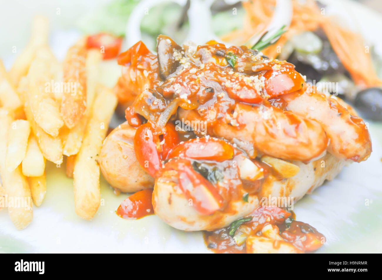 mixed sausage,sausage with gravy sauce topping dish Stock Photo - Alamy