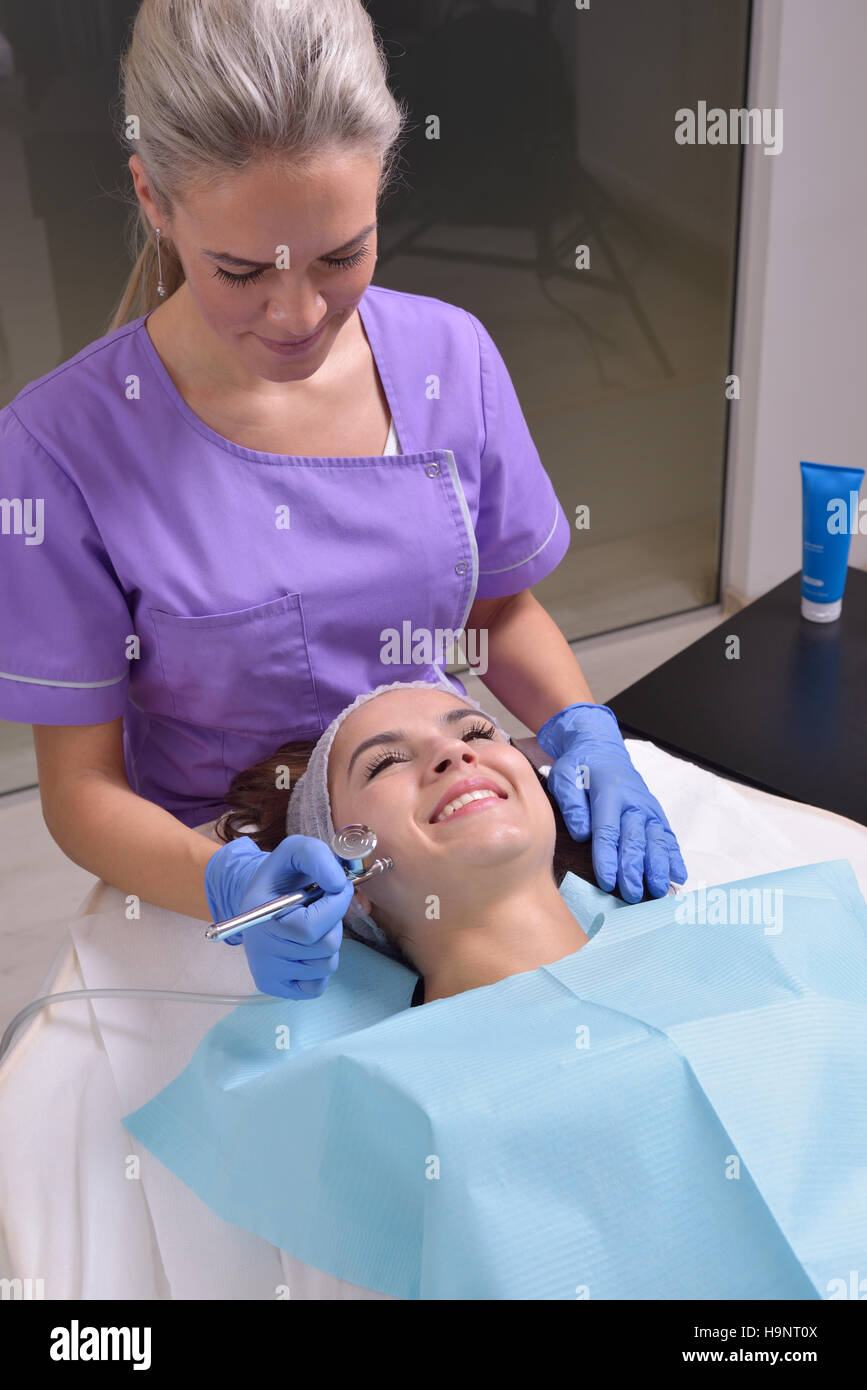 Young beautiful woman gets professional skin treatment in a beauty ...