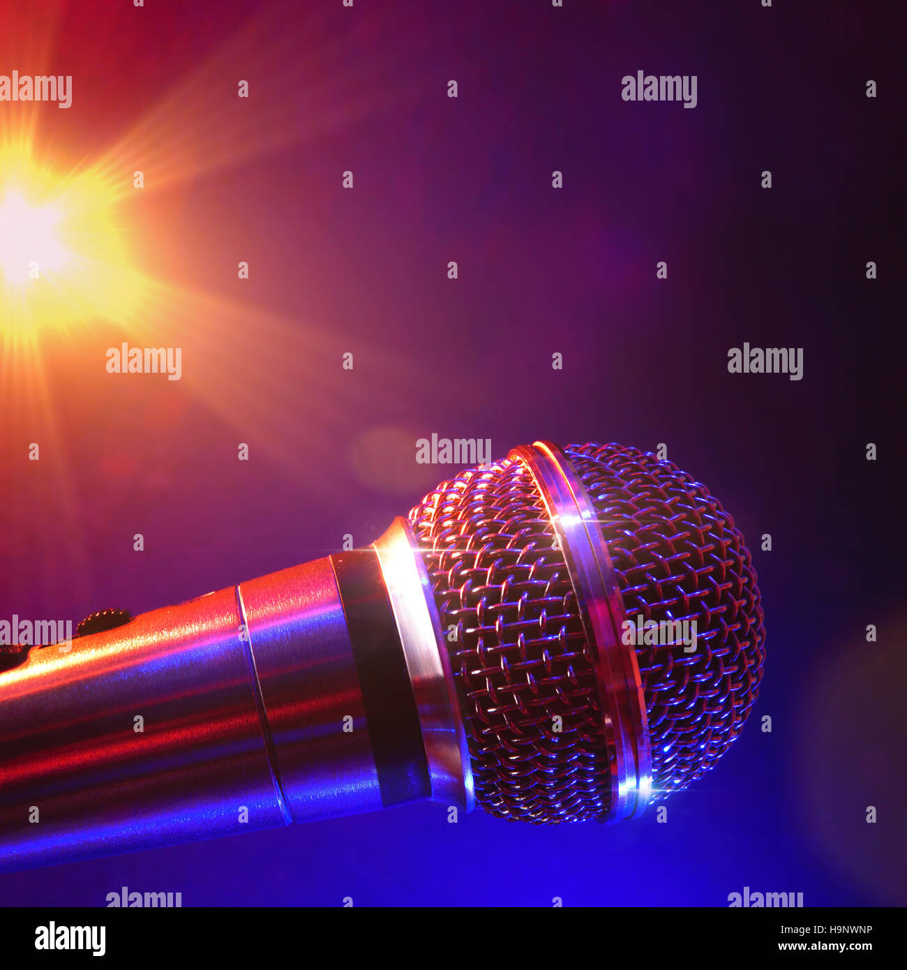 Close up microphone with lights in the background. Front view. Square ...
