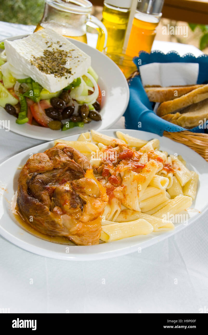 Greek food classic veal stifada with pasta Greek salad crusty bread ...