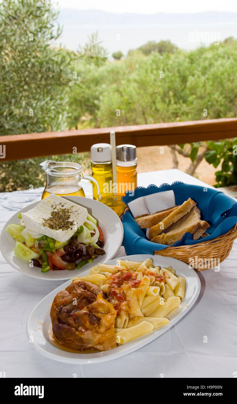 Greek food classic veal stifada with pasta Greek salad crusty bread ...