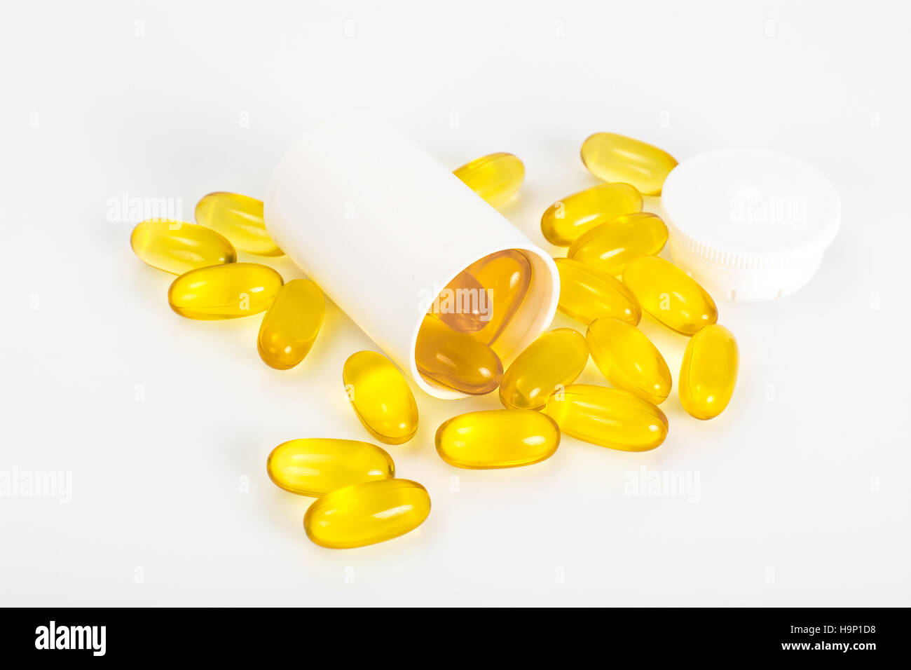 Vitamin E capsules on a white background Stock Photo - Alamy