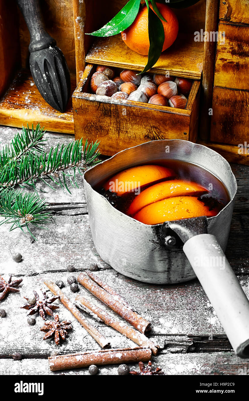 Hot red wine with oranges and cupboard with spices Stock Photo - Alamy