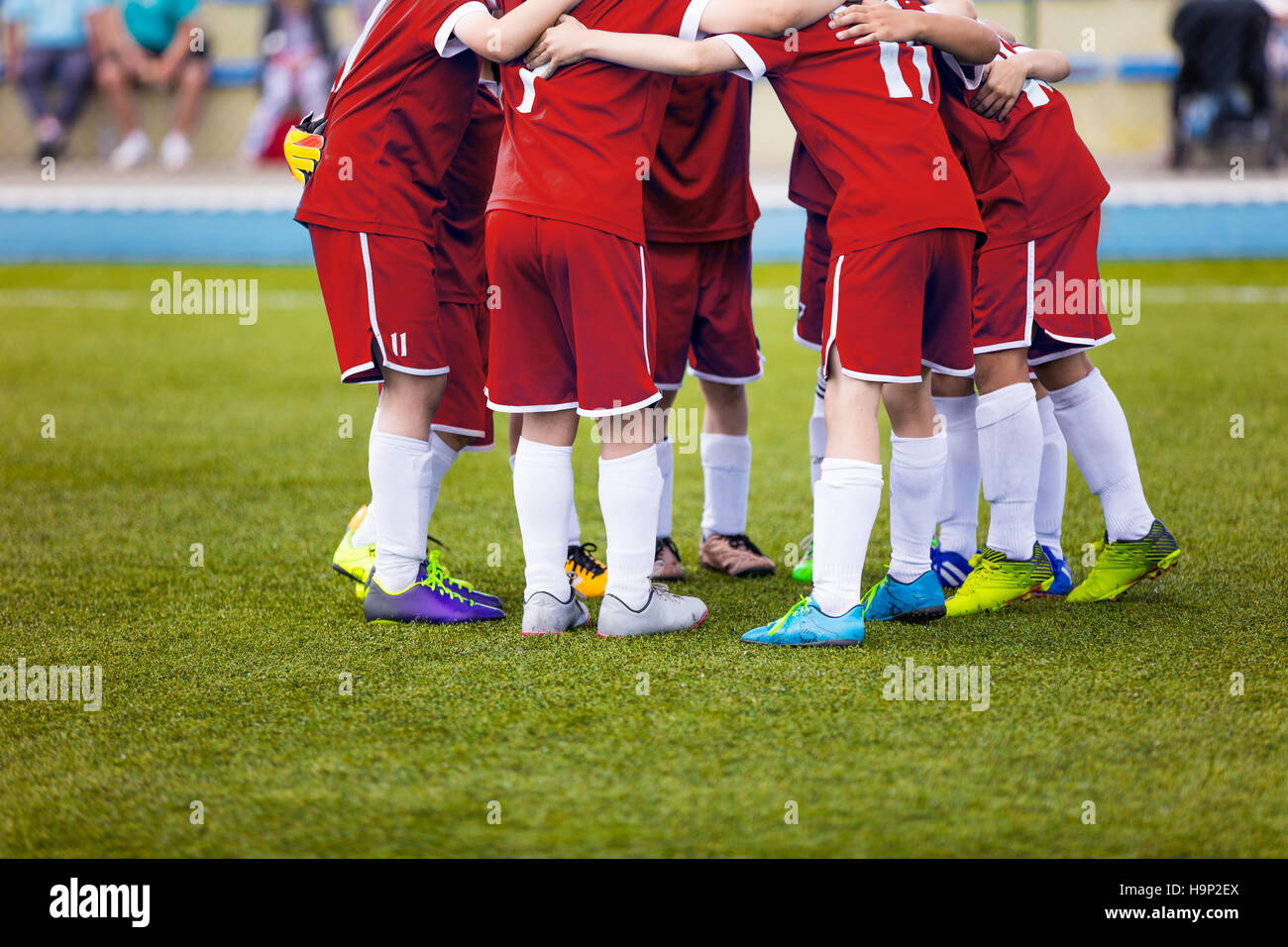 Young football soccer players in red sportswear. Young sports team on ...
