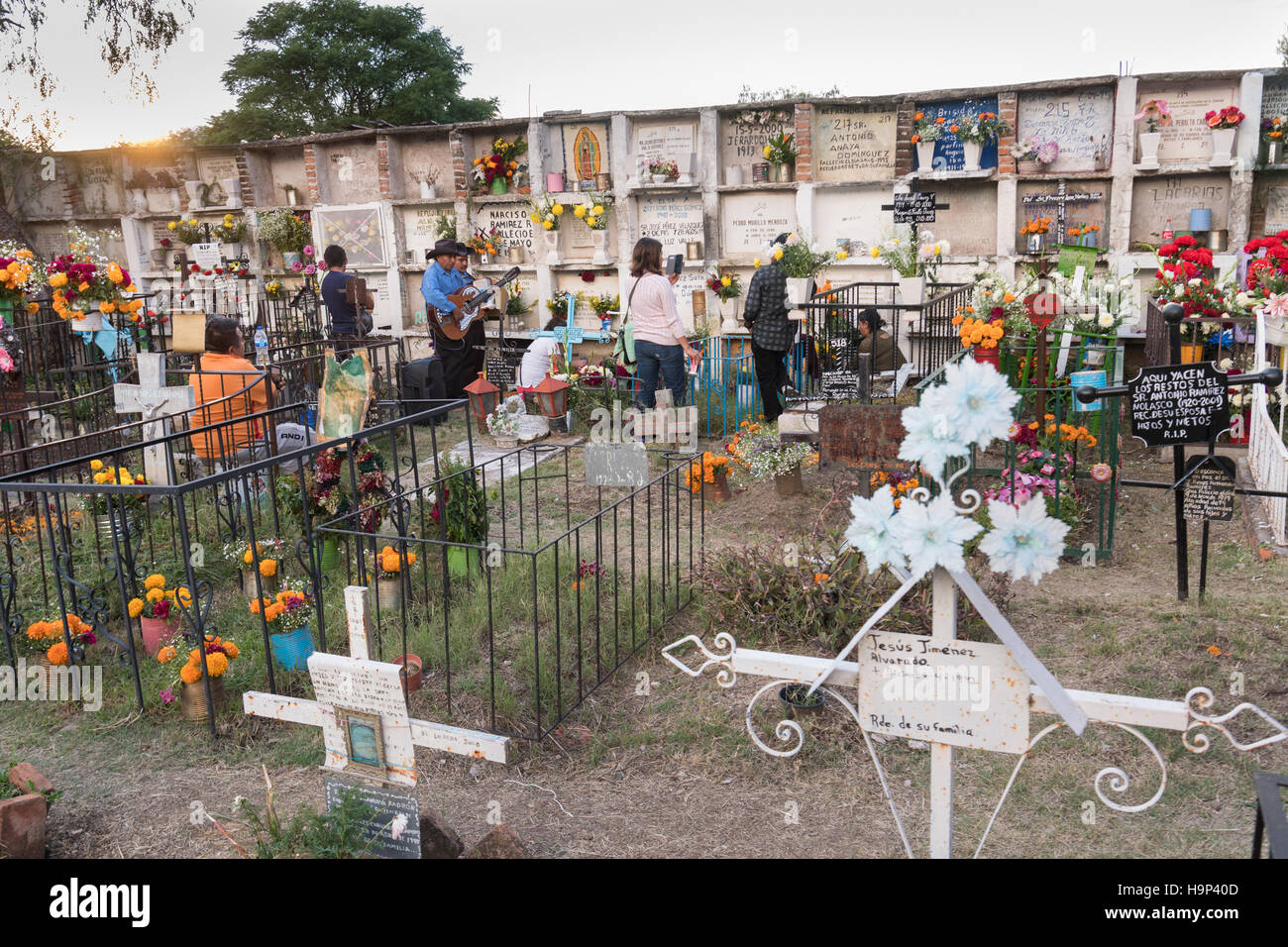 Mexican family visit the graves of a relative in the Nuestra Se–ora de ...
