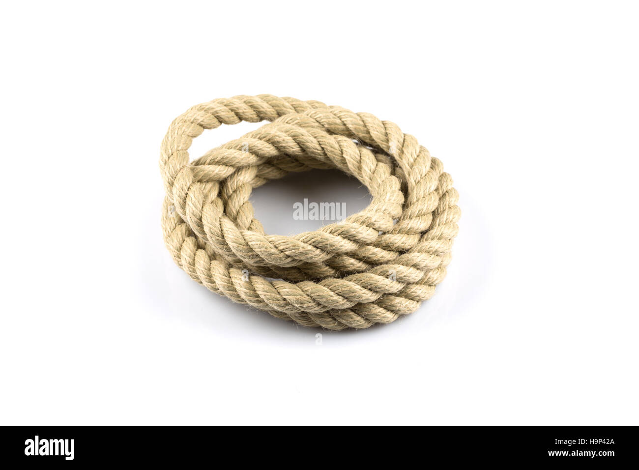 Twisted thick rope isolated on white background Stock Photo - Alamy