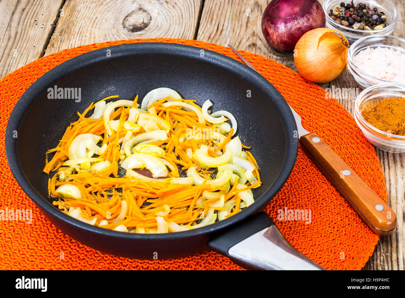 Roasted carrots and onions in a frying pan Stock Photo - Alamy