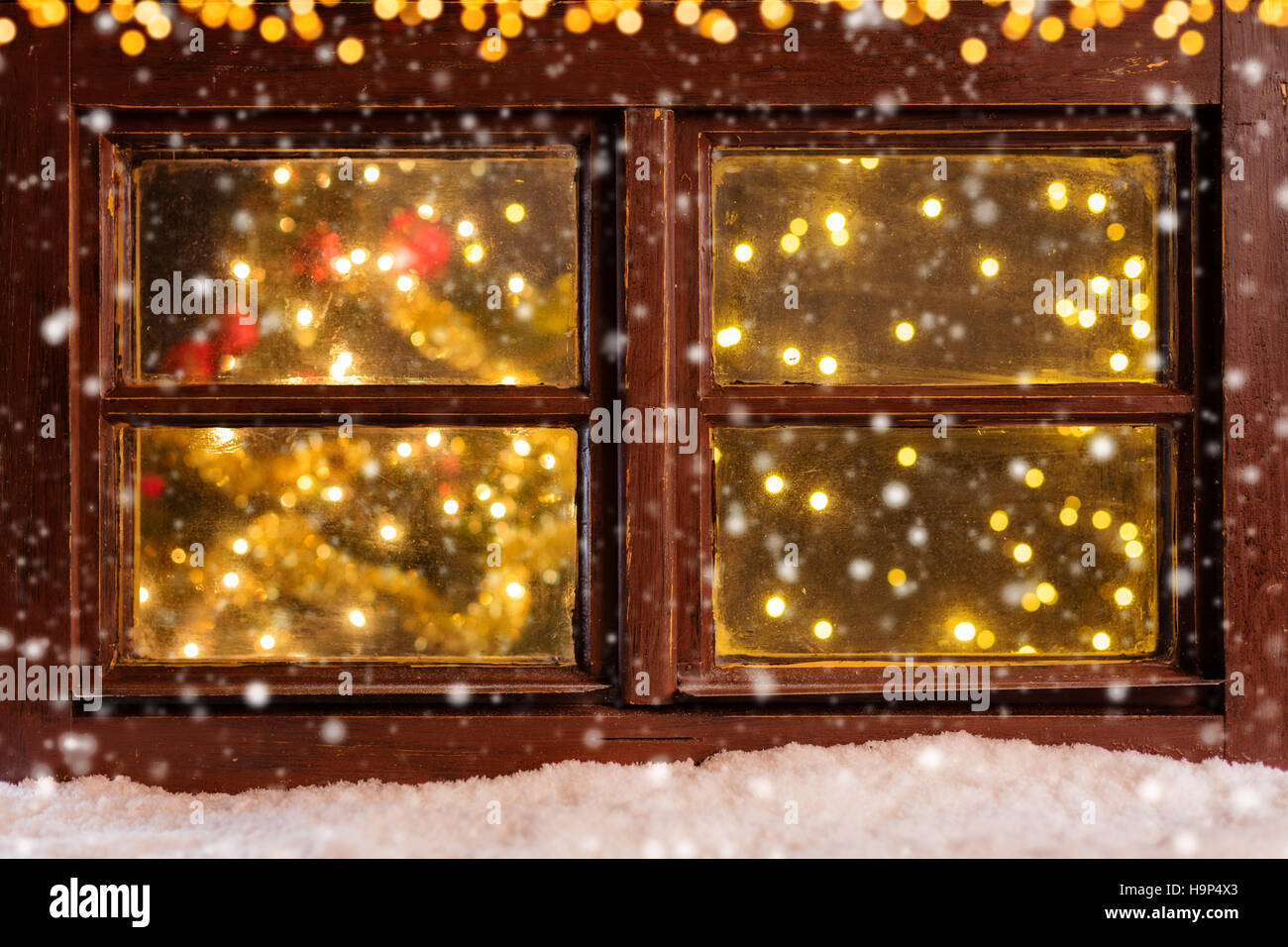Atmospheric Christmas window with falling snow and blur christmas tree ...