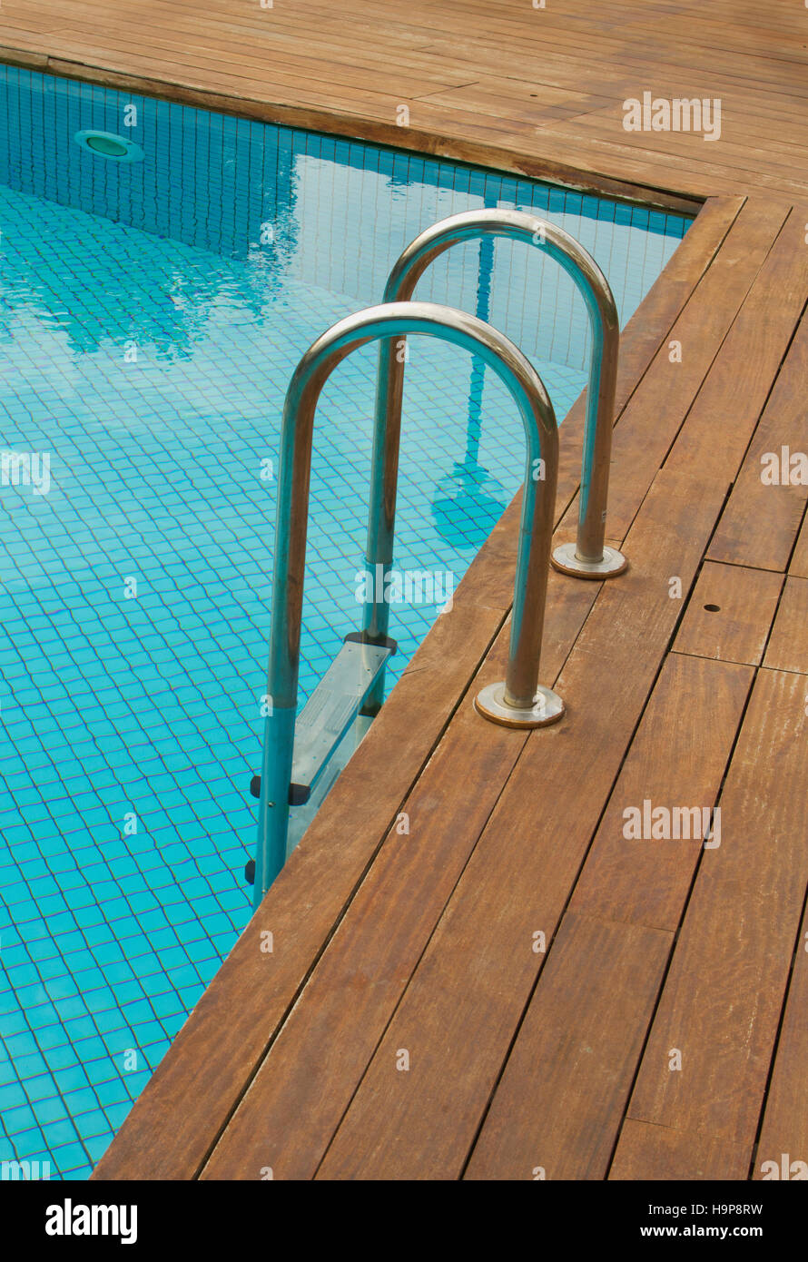 Swimming pool with old wooden flooring and blue water Stock Photo - Alamy