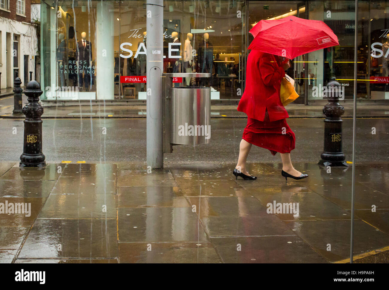 Lady in red dress with red umbrella Stock Photo - Alamy