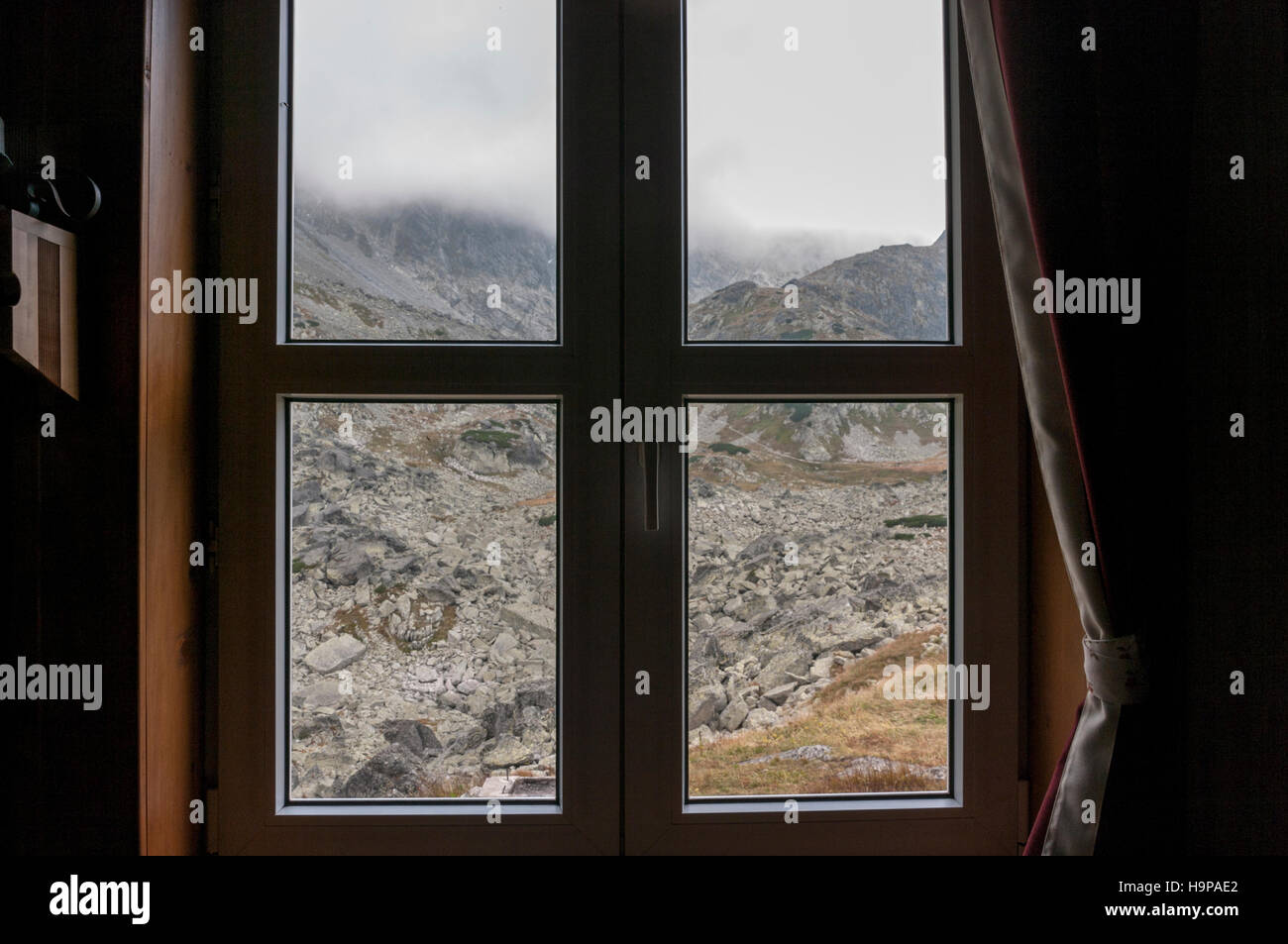 Window with a view of the mountains Stock Photo - Alamy