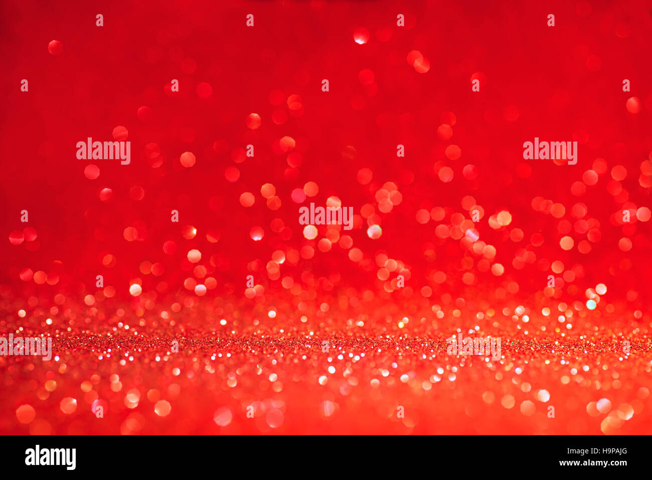 Red defocused background with flying glitters. Selective focus Stock ...
