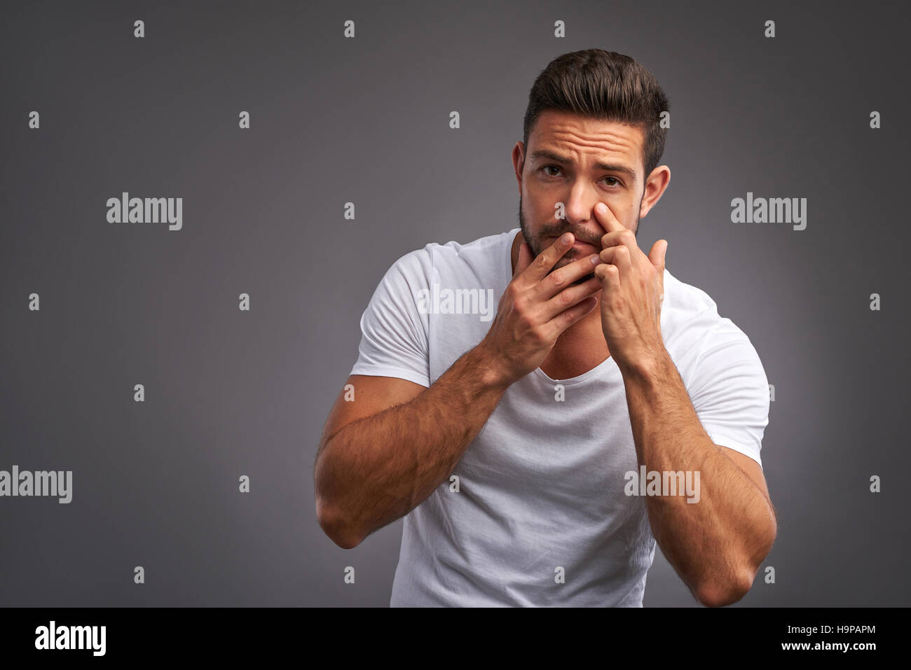 A handsome young man checking the skin on his face Stock Photo - Alamy