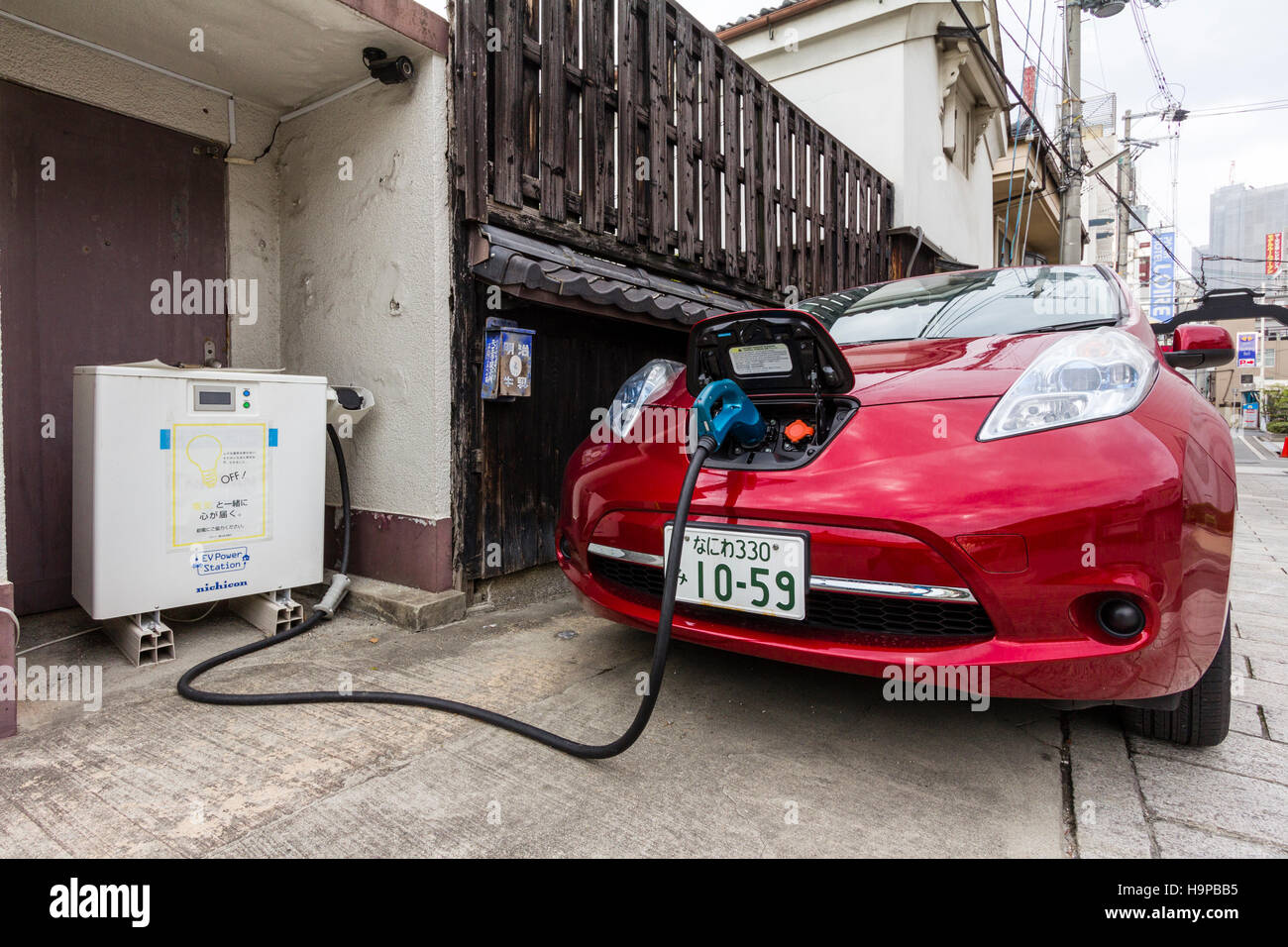 Japan, Osaka, Tennoji. Red crimson Japanese electric car parked in ...