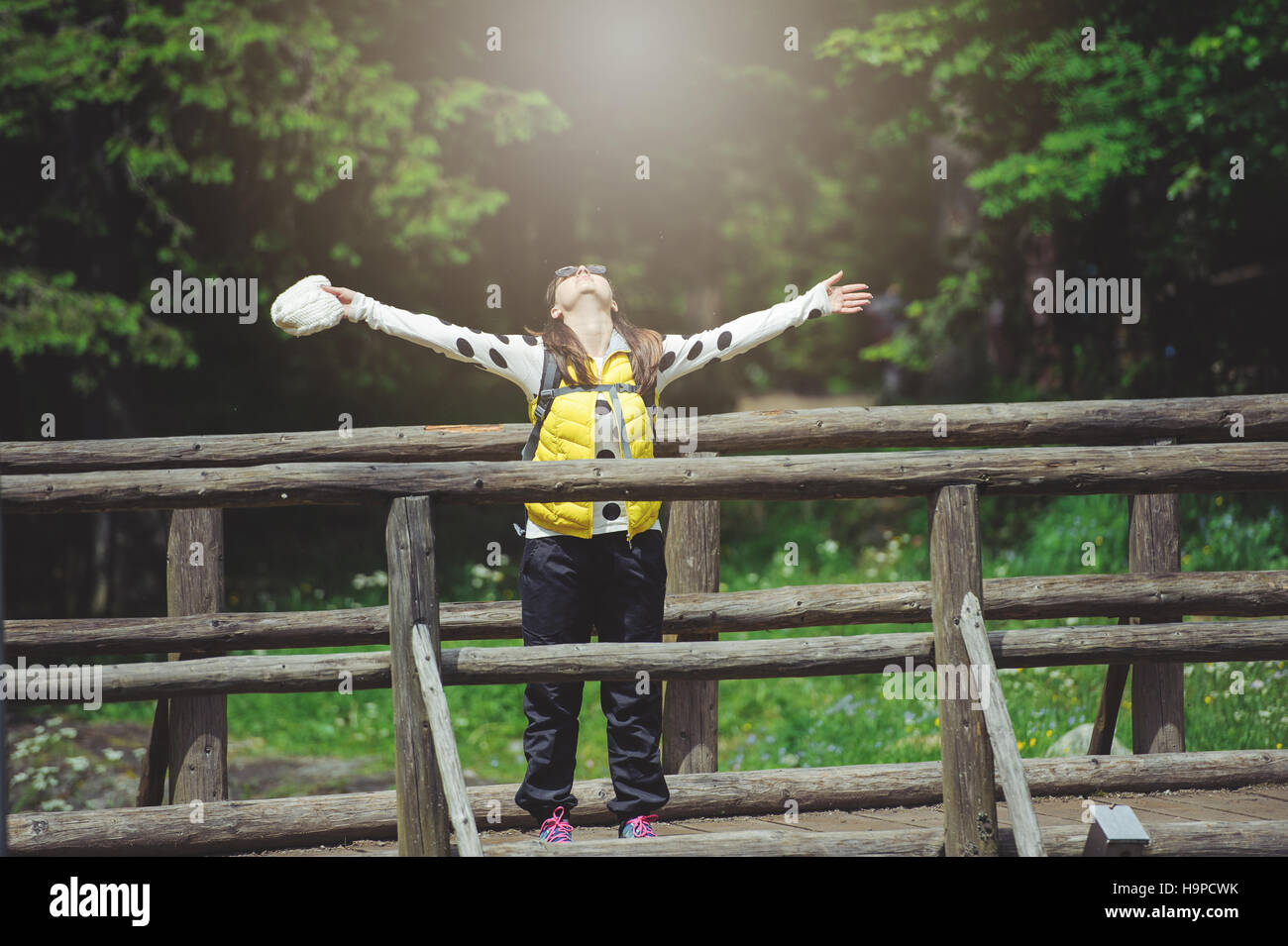 Woman walking over wooden bridge Stock Photo - Alamy