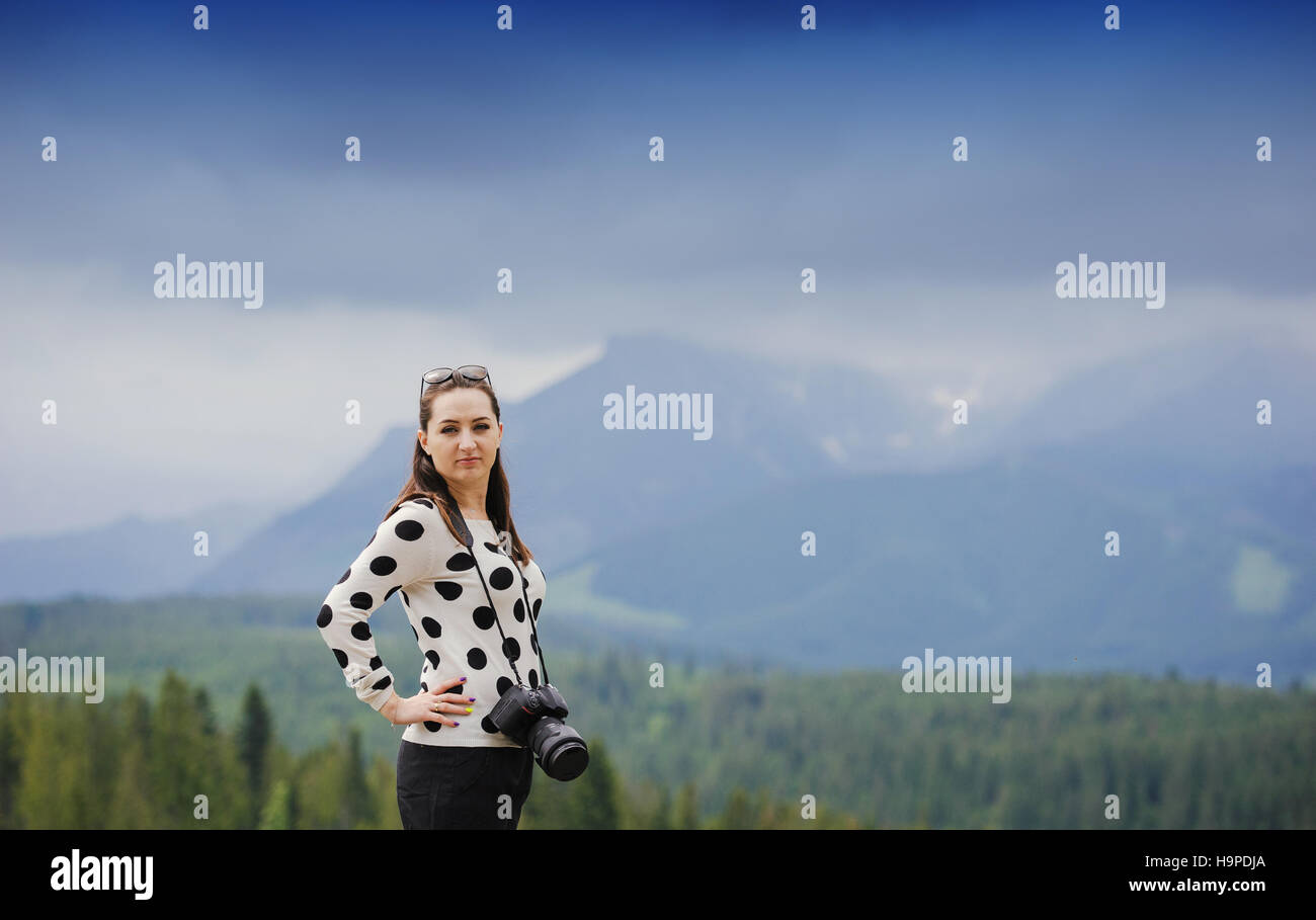 Woman photographer takes pictures in mountain Stock Photo - Alamy