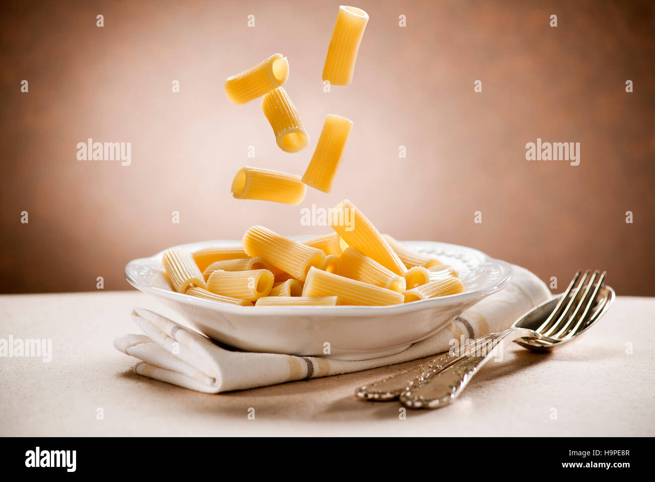 Fresh falling macaroni pasta close up shoot Stock Photo - Alamy