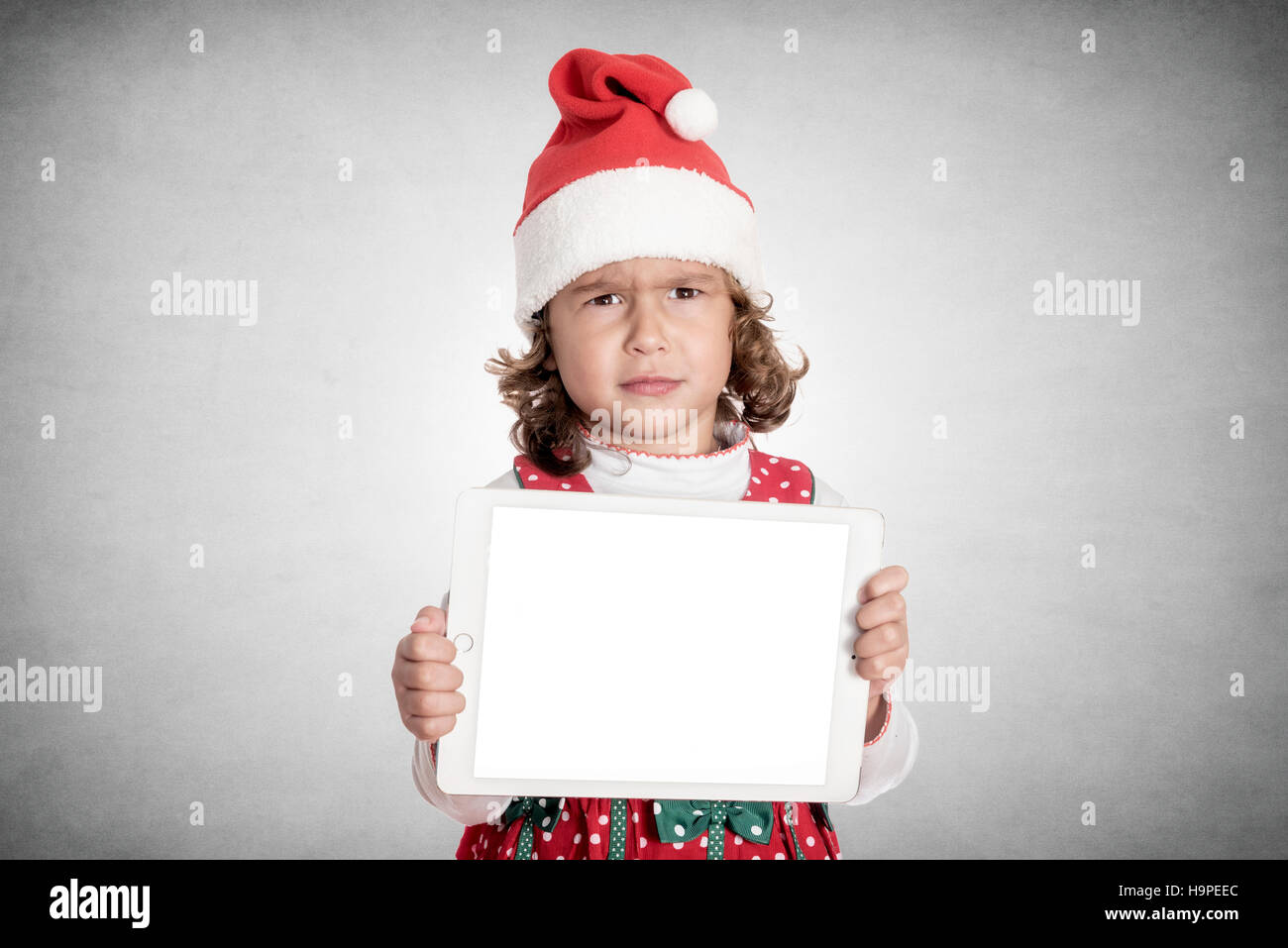 Portrait of angry little Santa holding blank screen tablet pc,isolated ...