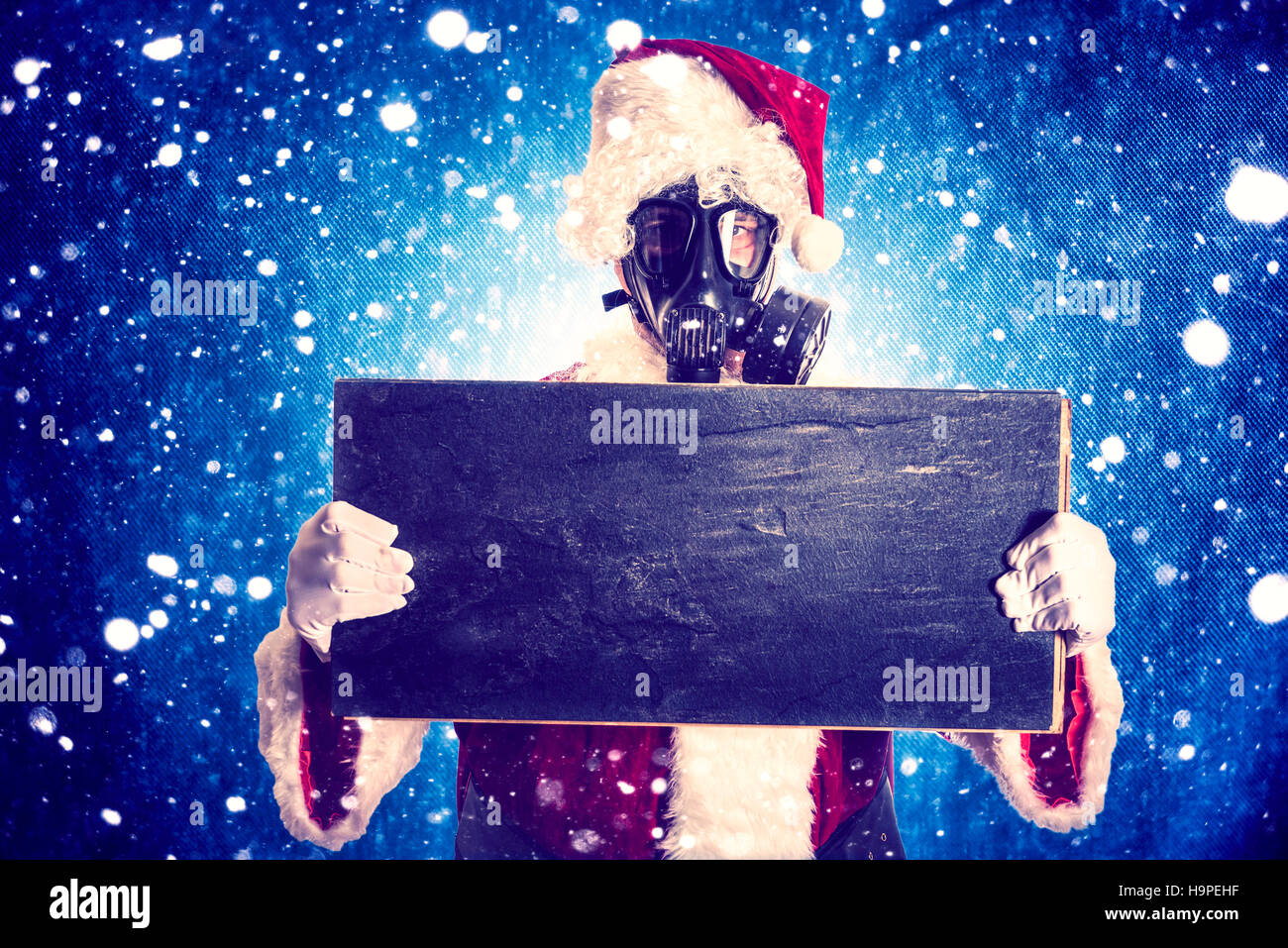 Santa Claus with gas mask holding blank chalkboard Stock Photo - Alamy