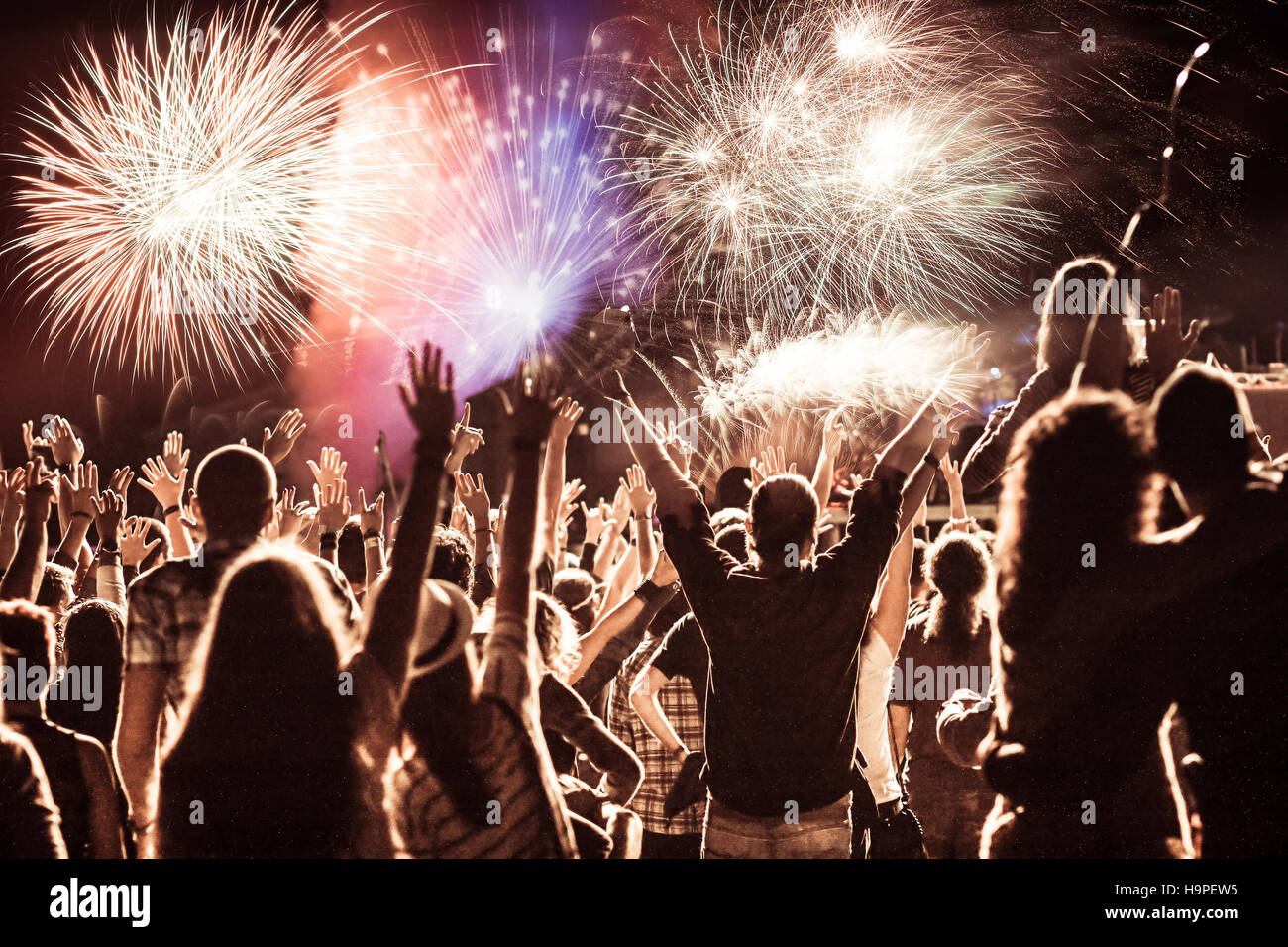 New Year concept - cheering crowd and fireworks Stock Photo - Alamy
