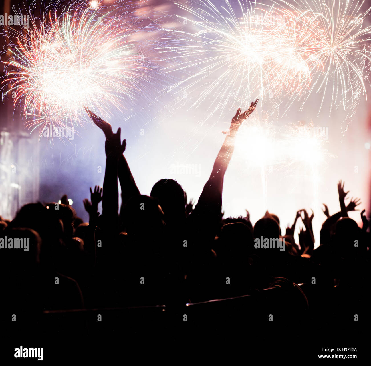 New Year concept - cheering crowd and fireworks Stock Photo - Alamy