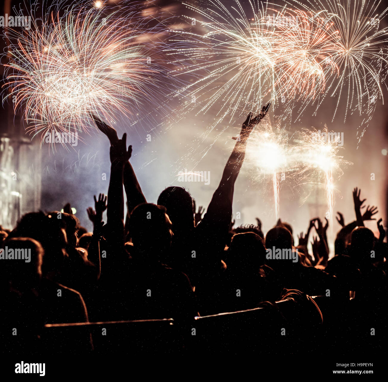 New Year concept - cheering crowd and fireworks Stock Photo - Alamy