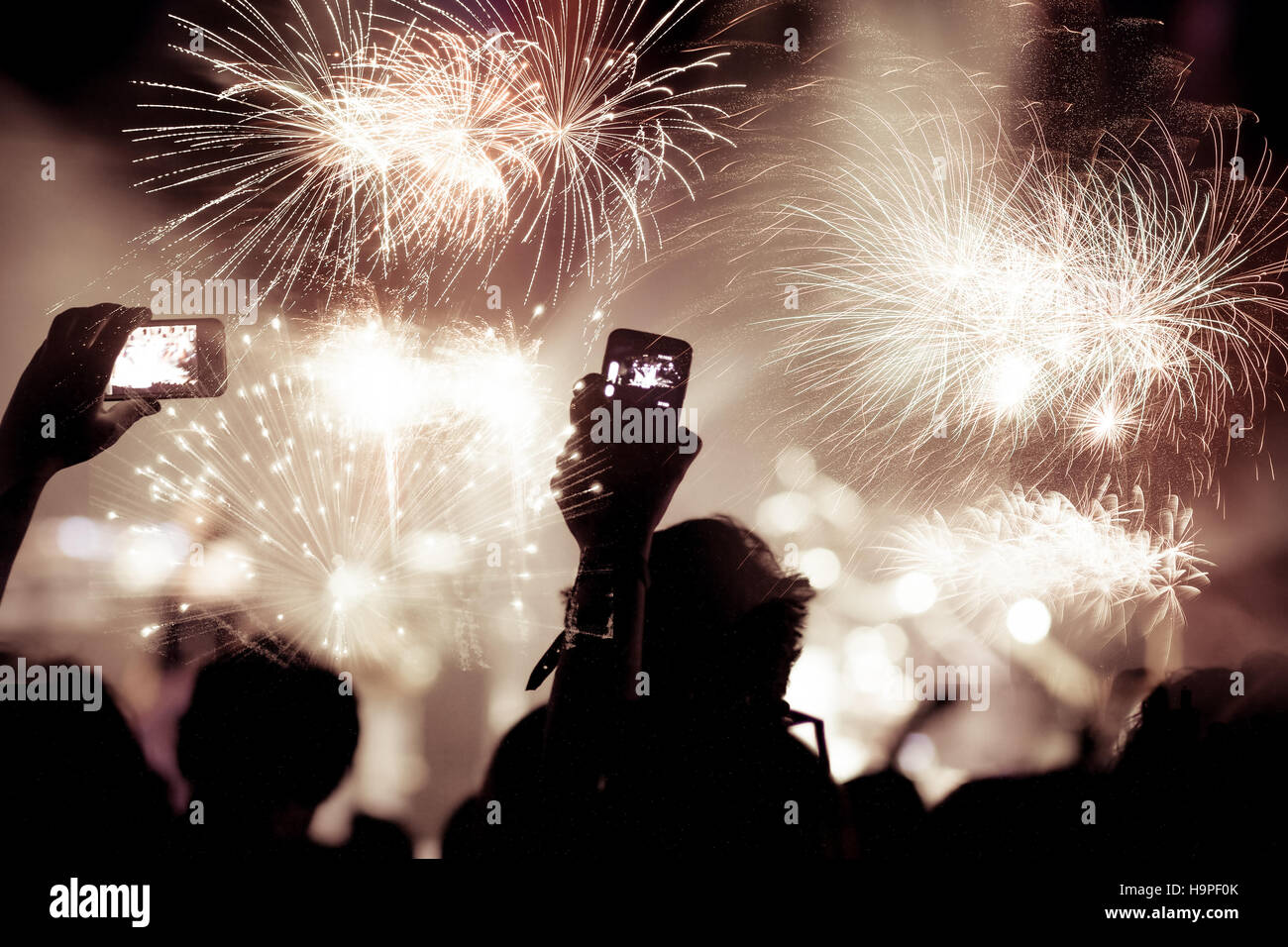 New Year concept - cheering crowd and fireworks Stock Photo - Alamy