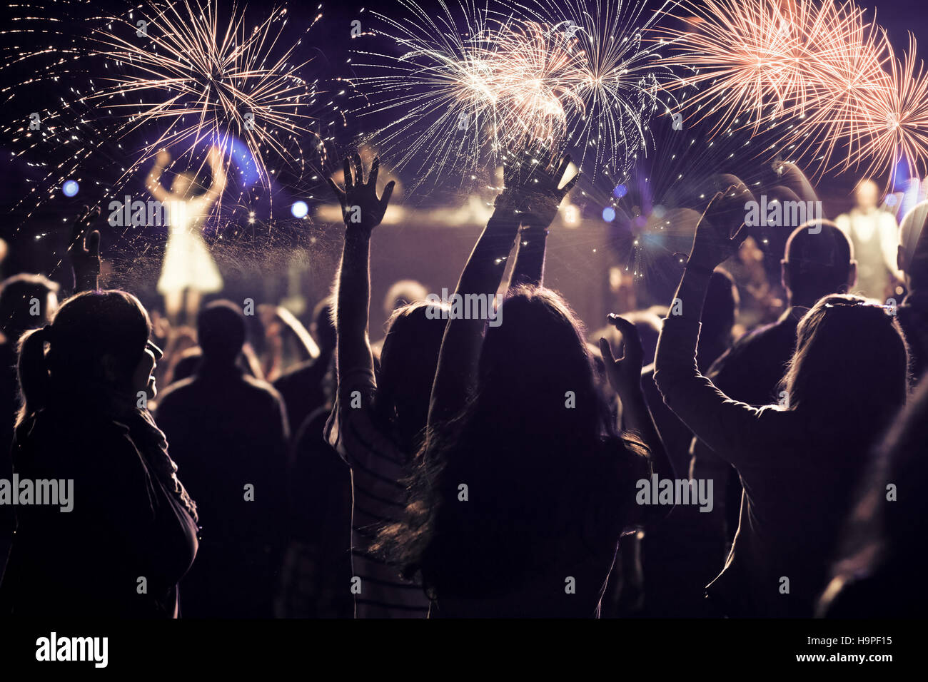 New Year concept - cheering crowd and fireworks Stock Photo - Alamy