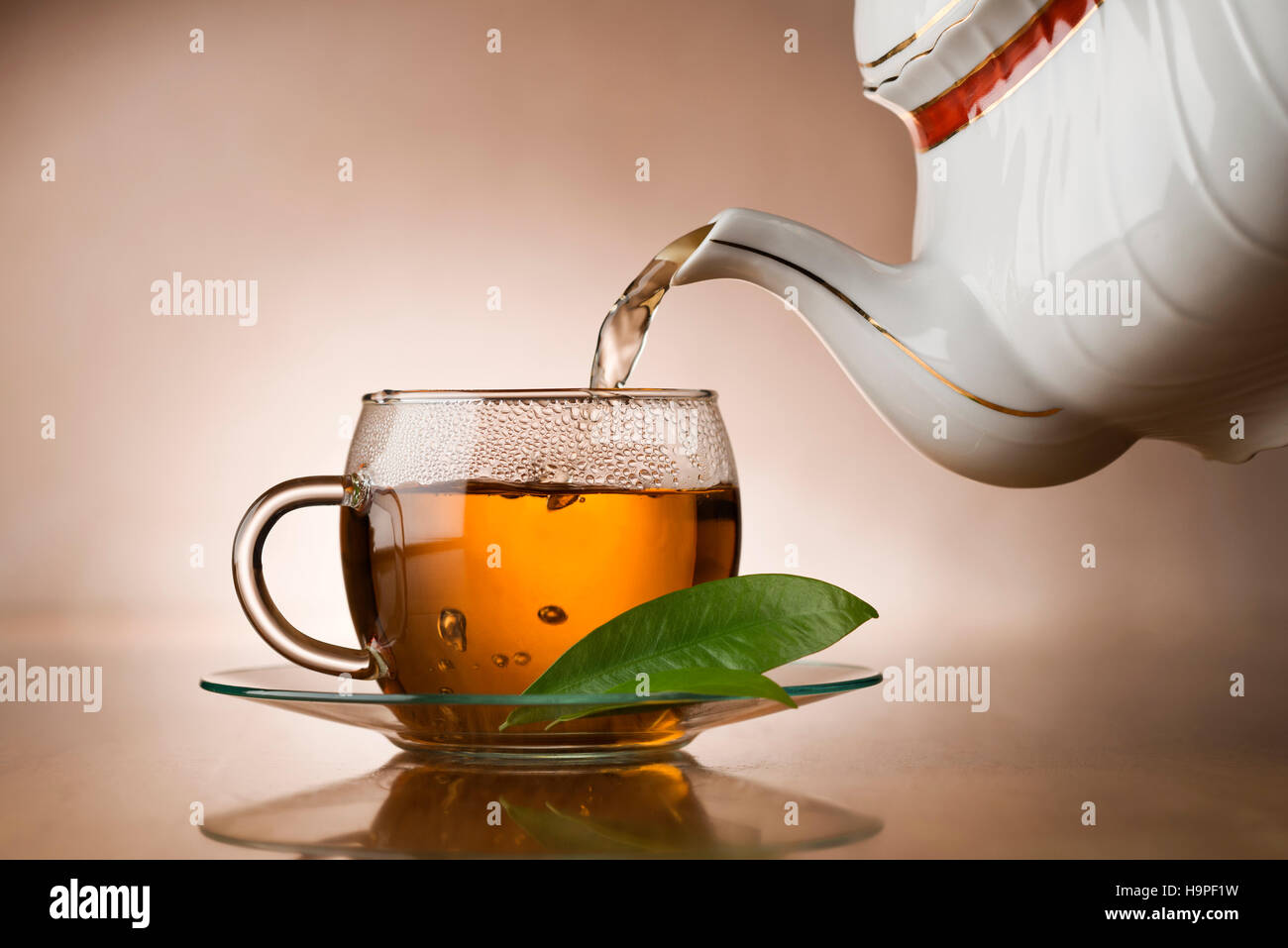 Tea pouring into cup hi-res stock photography and images - Alamy
